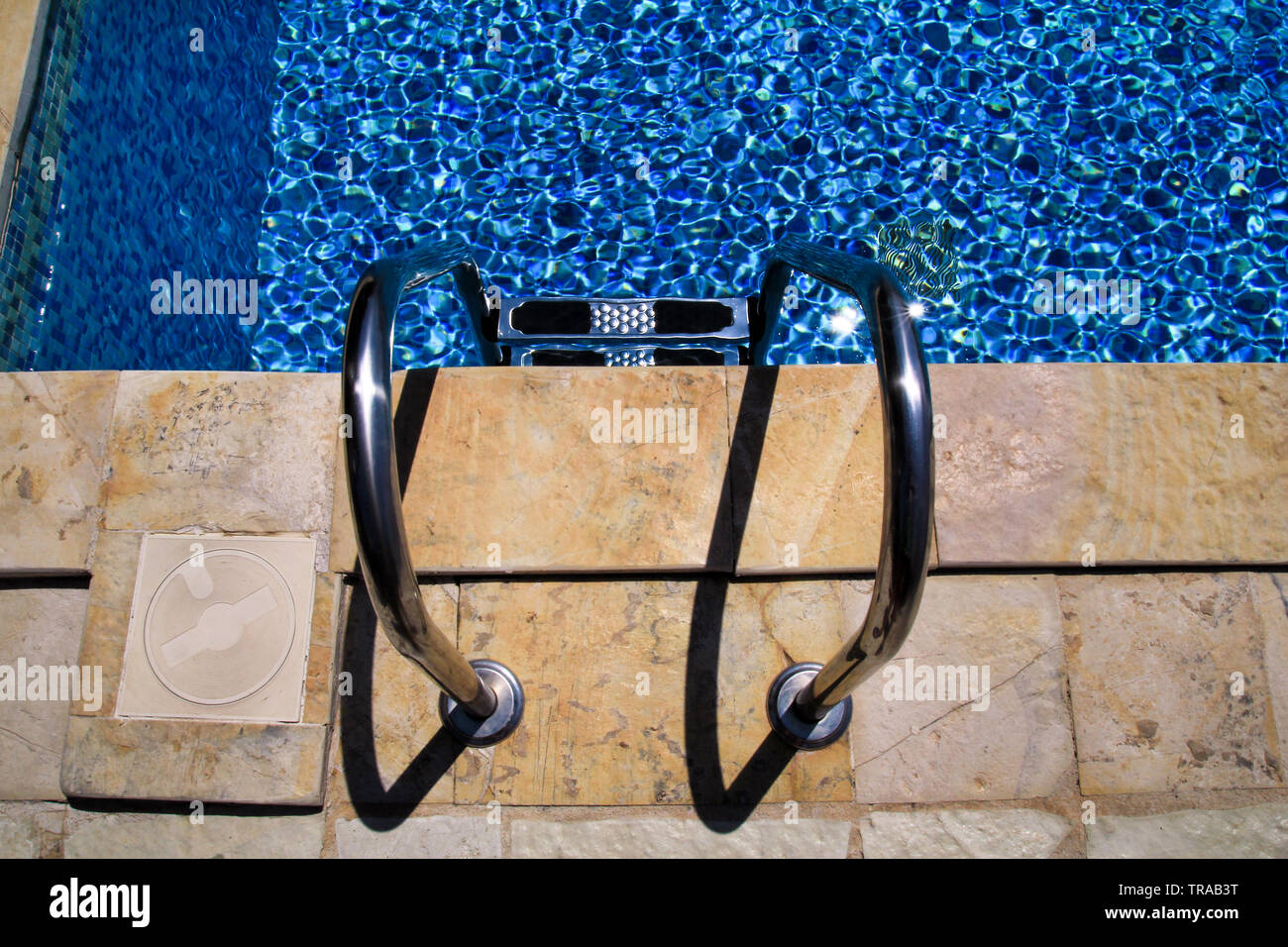 Handrail on pool. Swimming pool with stair at tropical resort. Pool ...