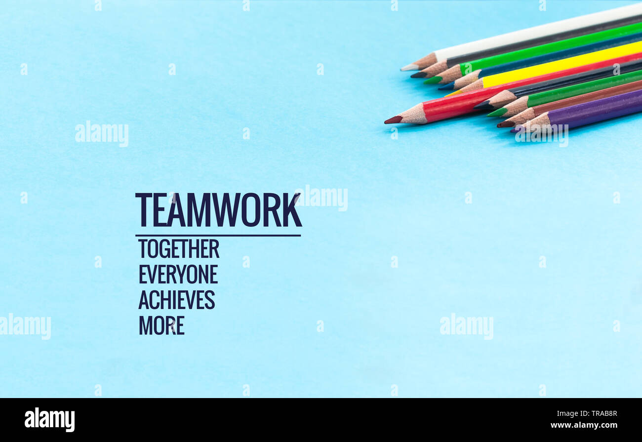 Teamwork concept. group of color pencil on blue background with word ...