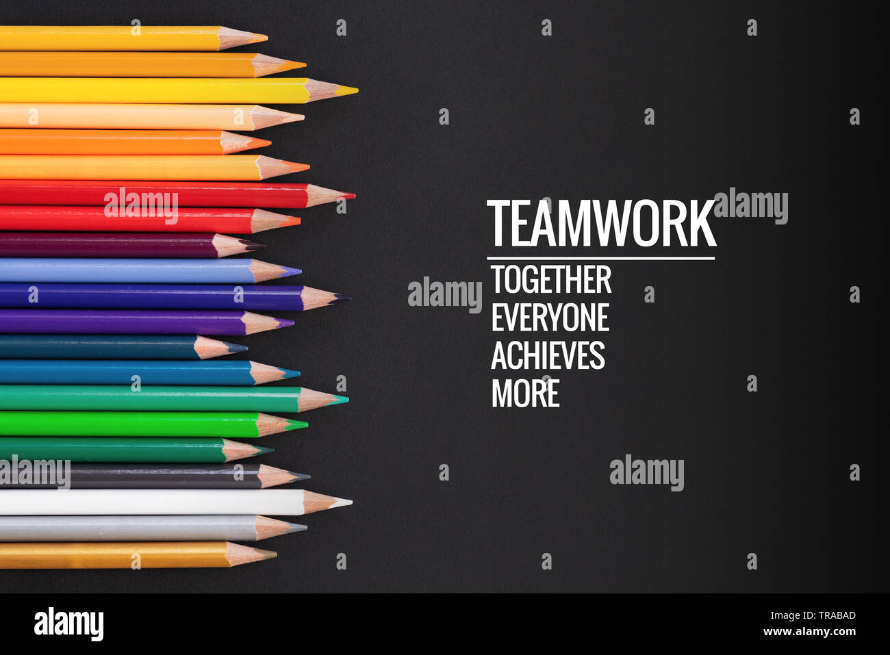 Teamwork concept. group of color pencil on black background with word ...