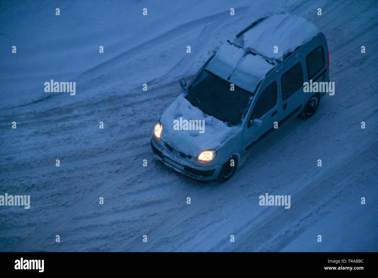 Transportation, winter season. Car moving covered in snow after ...