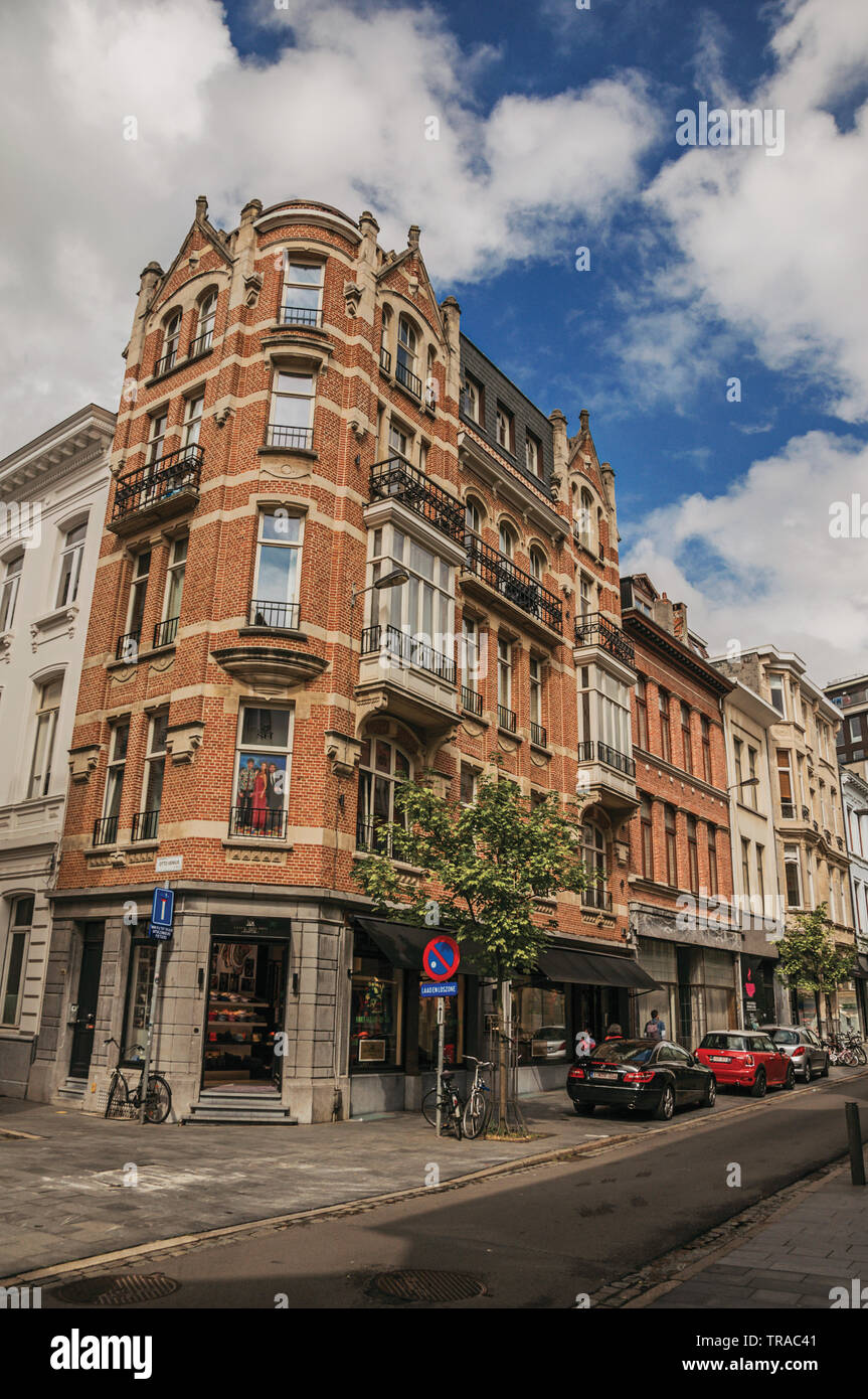People and buildings in a street of Antwerp. Multicultural city with ...