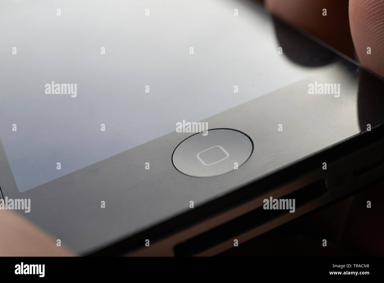Amazing close up of a finger about to press the home button of a touch ...