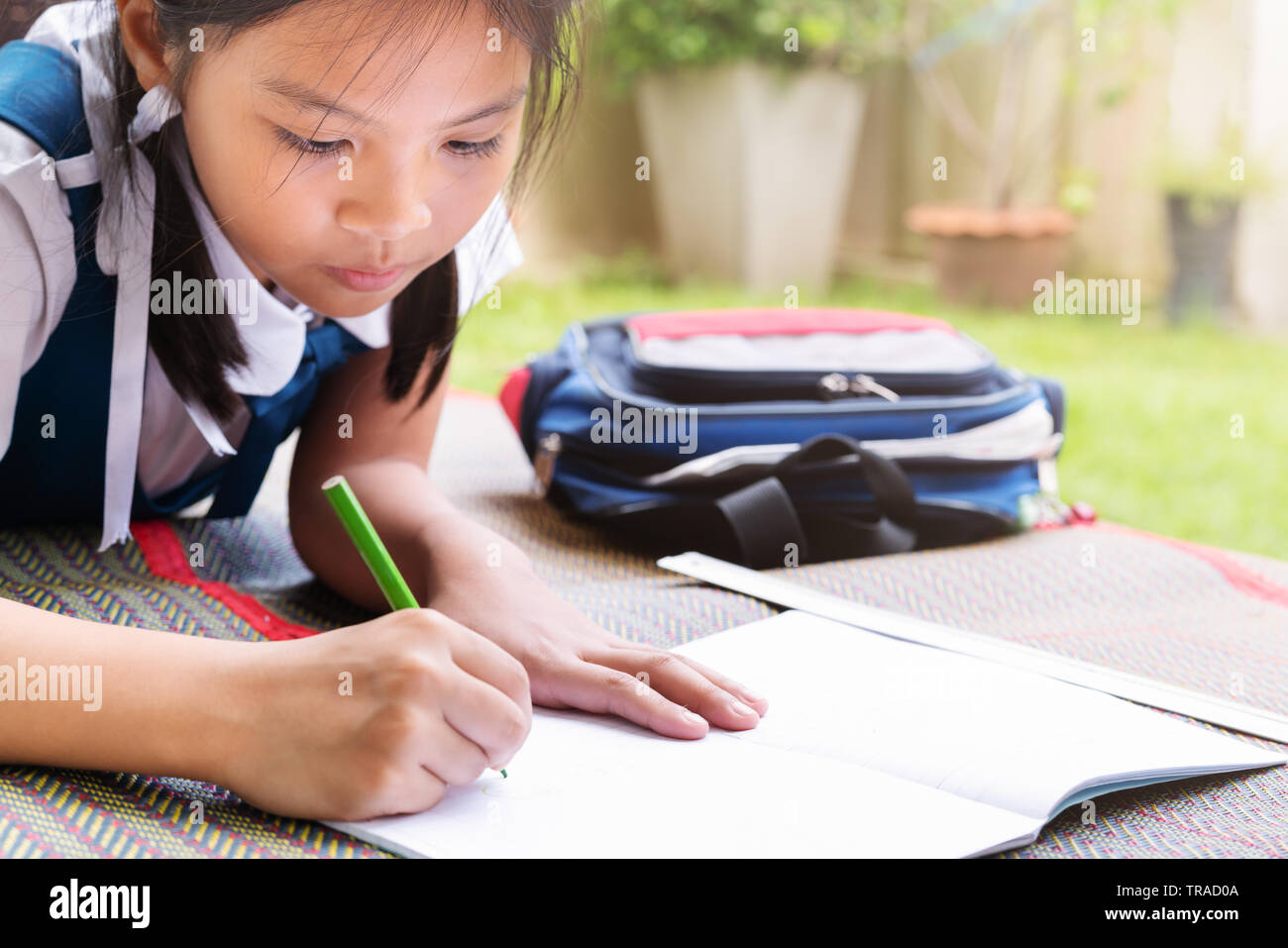 little girl writes to writing-books. The decision of lessons. girl lay ...