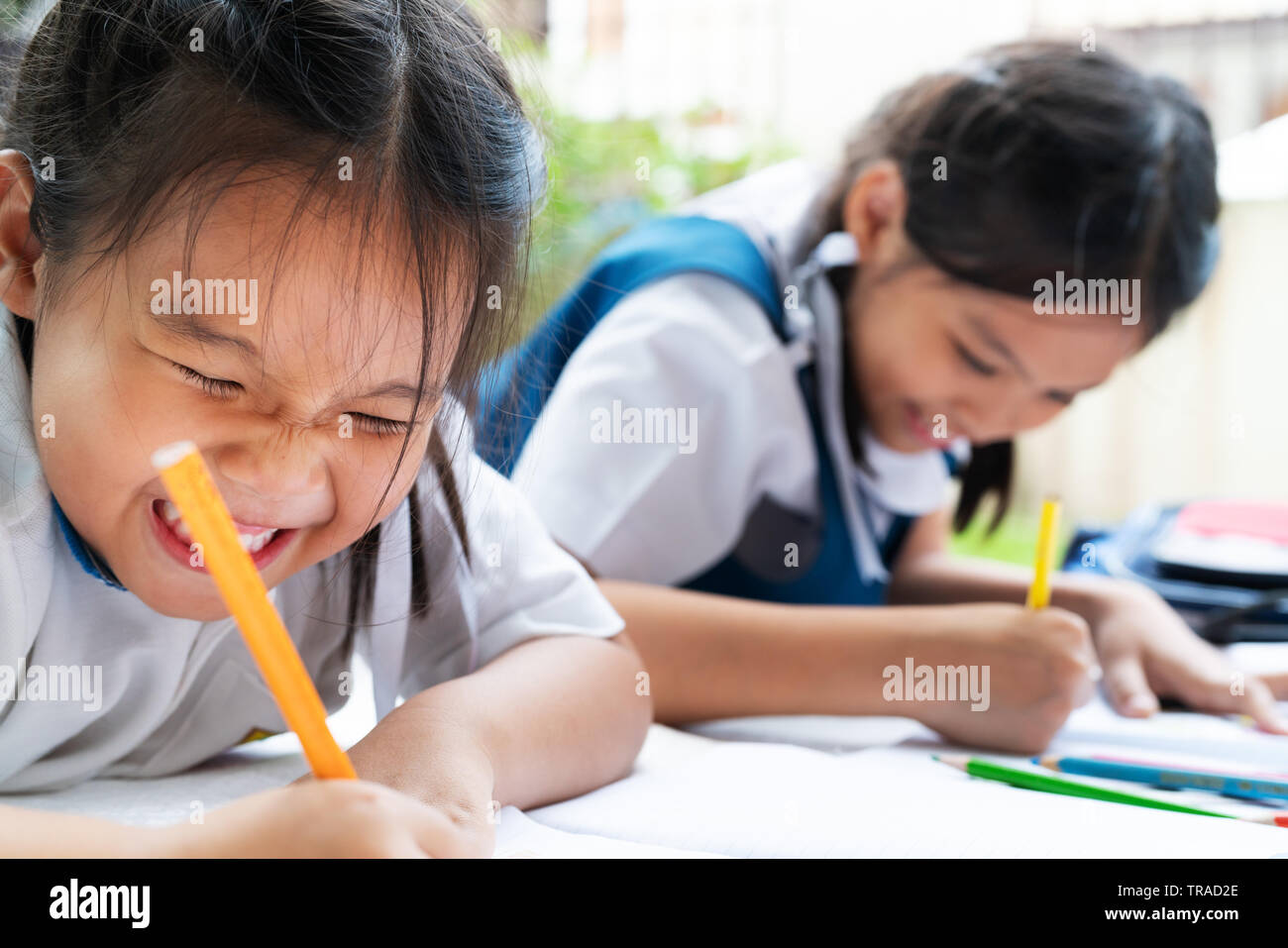 two sister girl writes to writing-books. The decision of lessons. girl ...