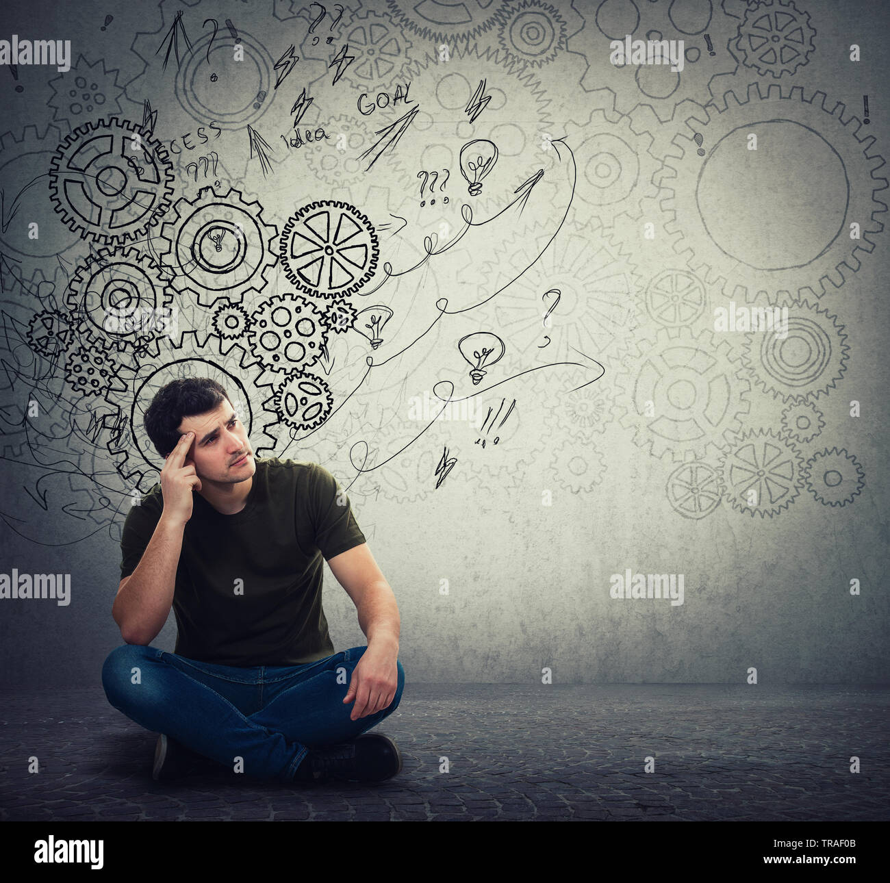 Man sitting on the floor hard thinking, find a solution to solve ...