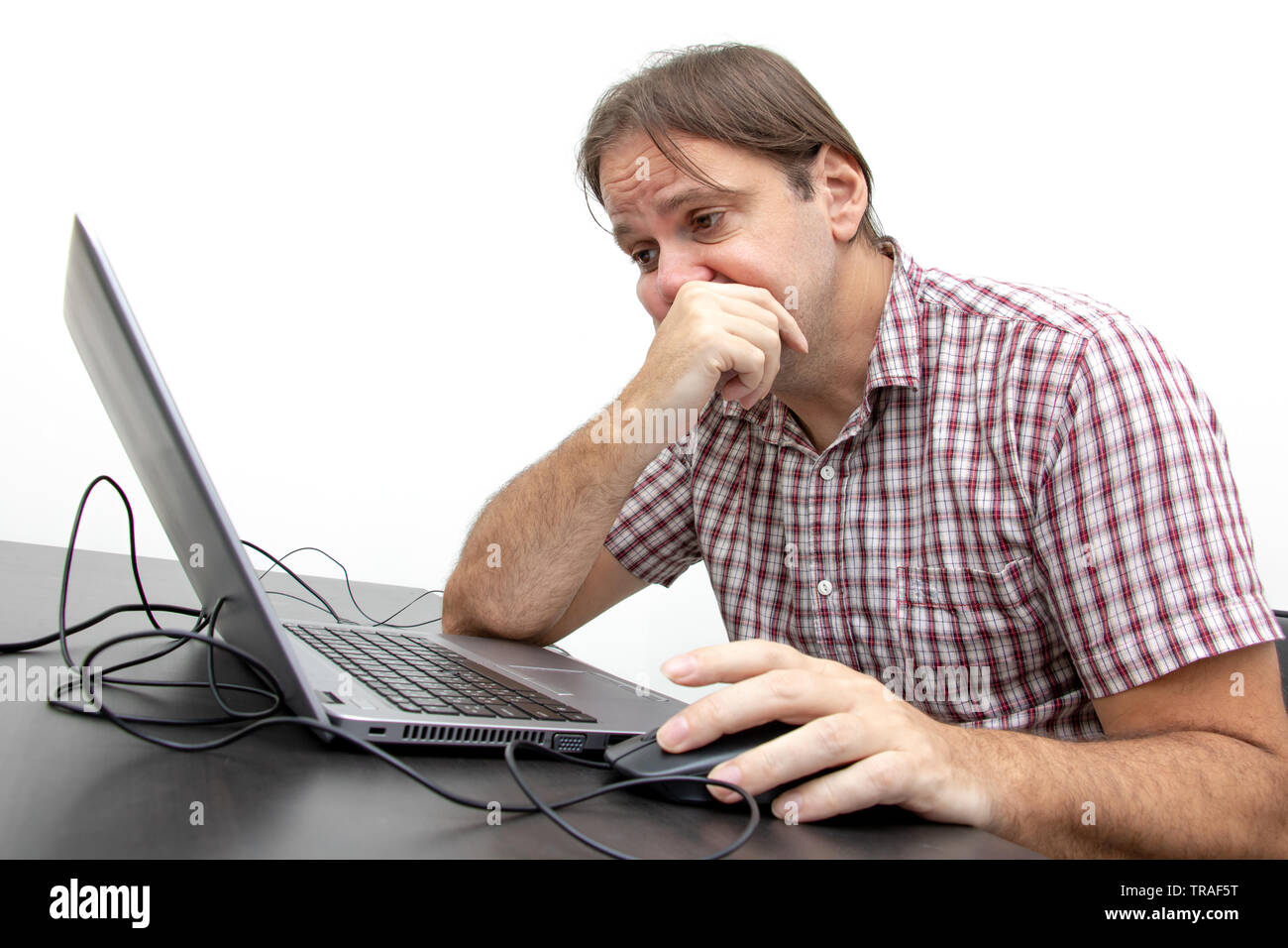 Unhappy user looking at display of notebook at office. A sadness man ...