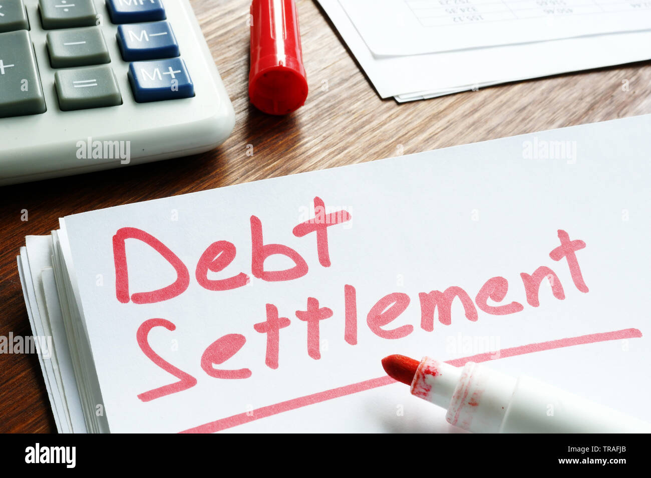 Debt Settlement handwritten on loan documents Stock Photo - Alamy