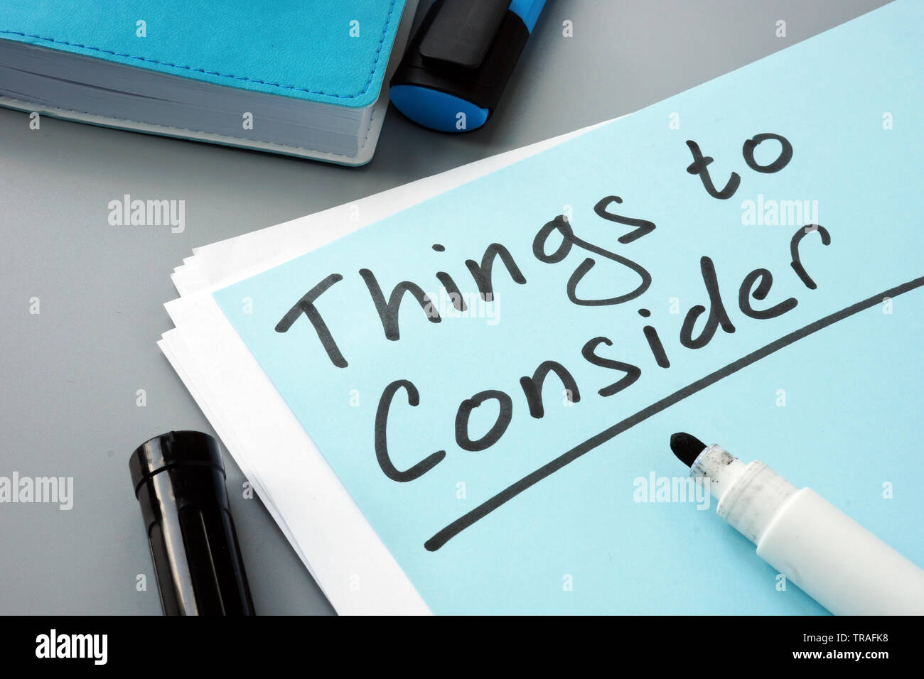 Man writes things to consider list in note Stock Photo - Alamy