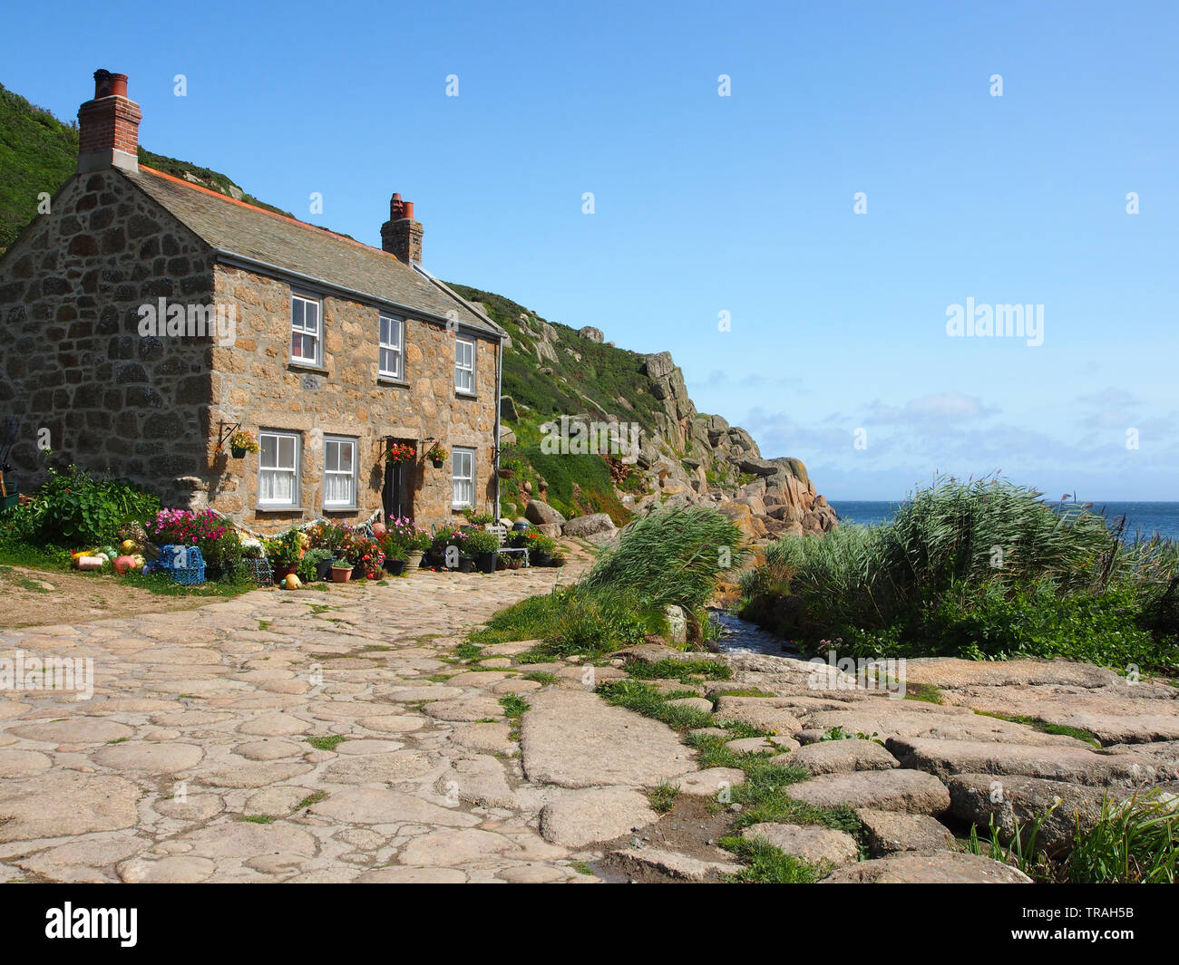 Typical Cornish cottage, built directly on the shoreline at Penberth ...