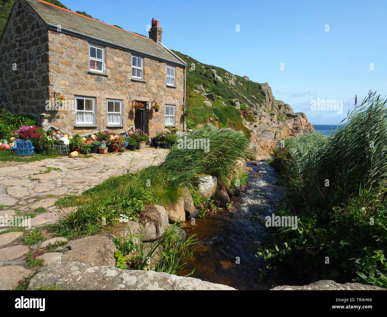 Typical Cornish cottage, built directly on the shoreline at Penberth ...