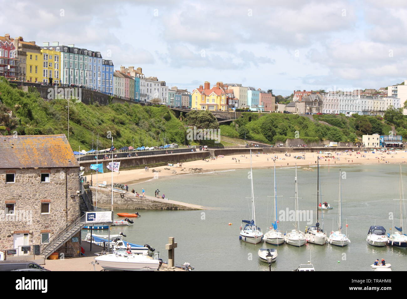 A photograph of Tenby harbour, Pembrokeshire, Wales, UK. Boats, people ...
