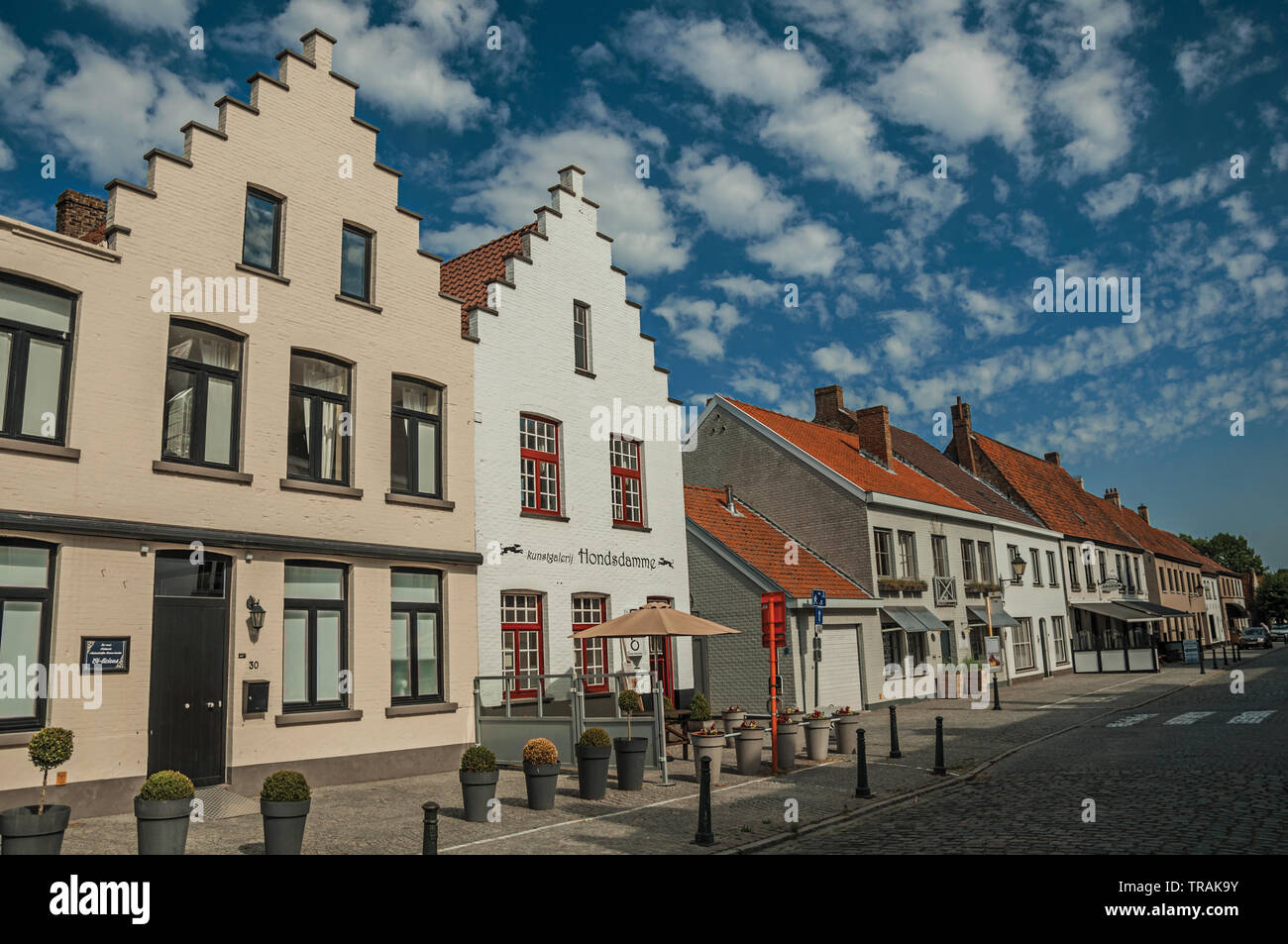 Typical style houses and restaurants in a street of Damme. A small and ...