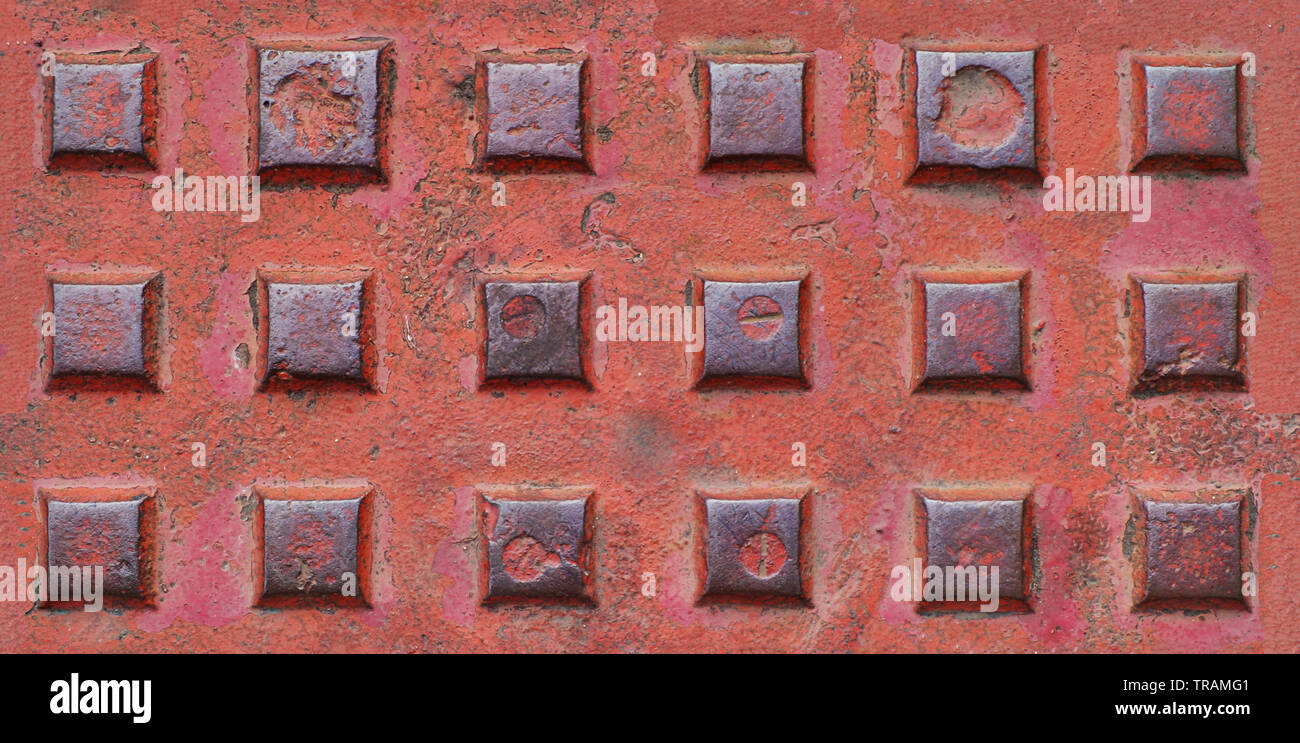 Detail of a red cast iron metal plate Stock Photo - Alamy