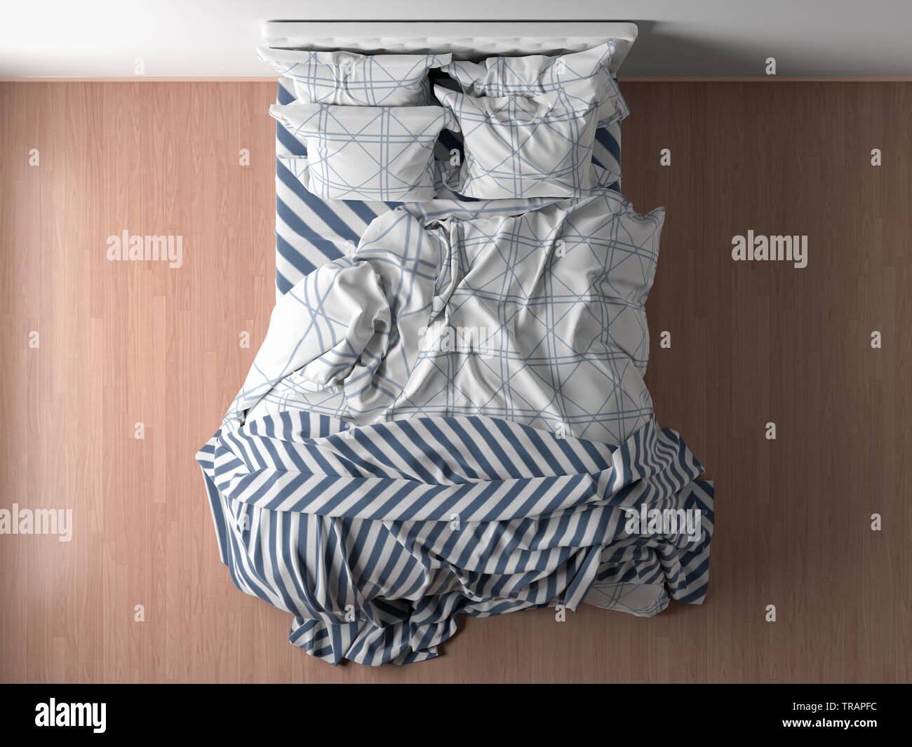 Bed with duvet, bedding and pillows on wooden floor in bedroom. Top ...