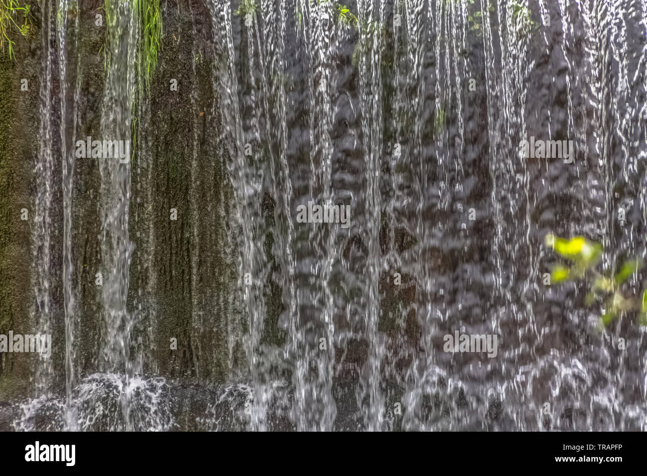 Detailed view of a small cascade on river, colorful and texture of ...