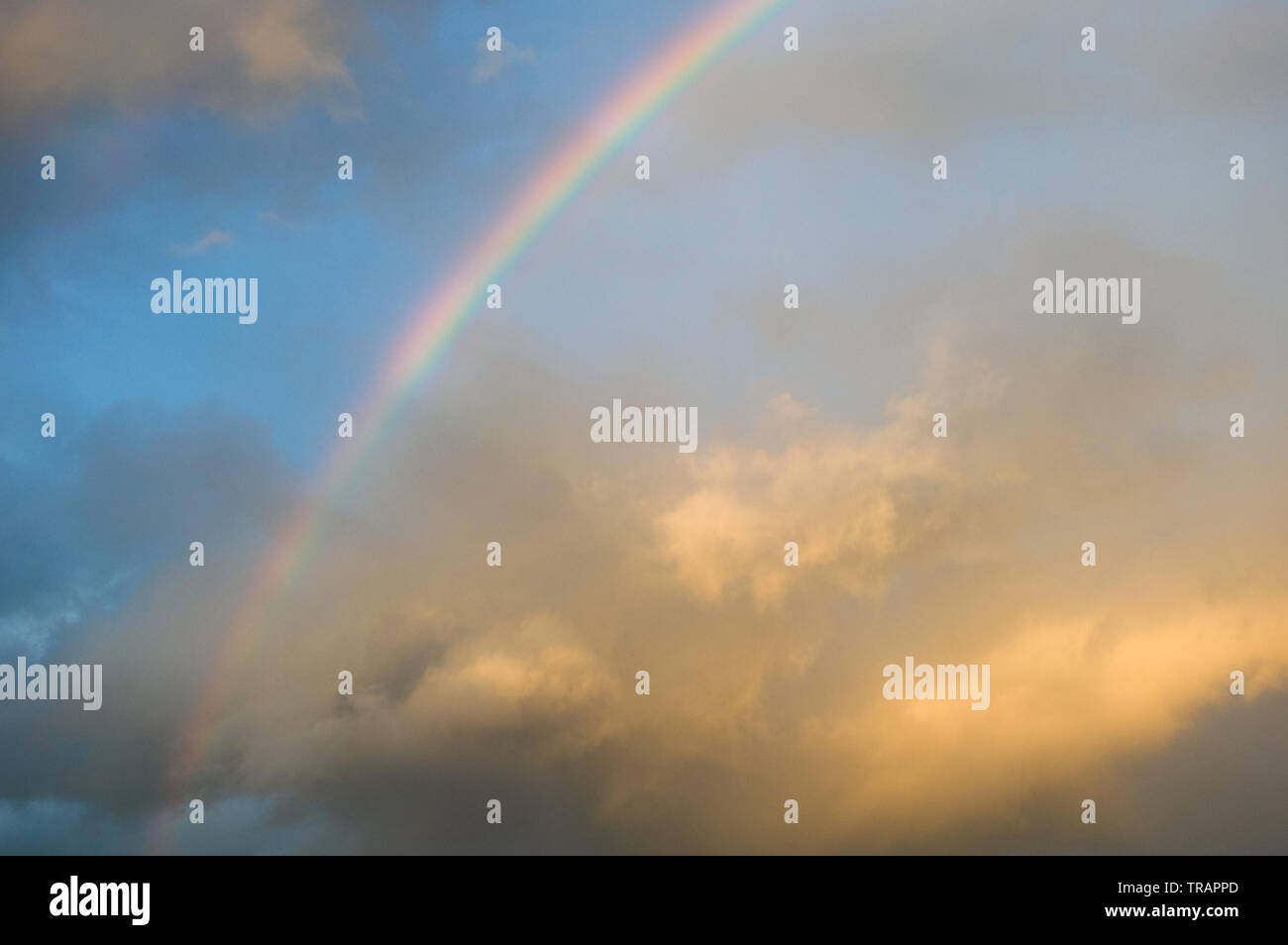 part of colorful rainbow in sunset cloudy sky Stock Photo - Alamy