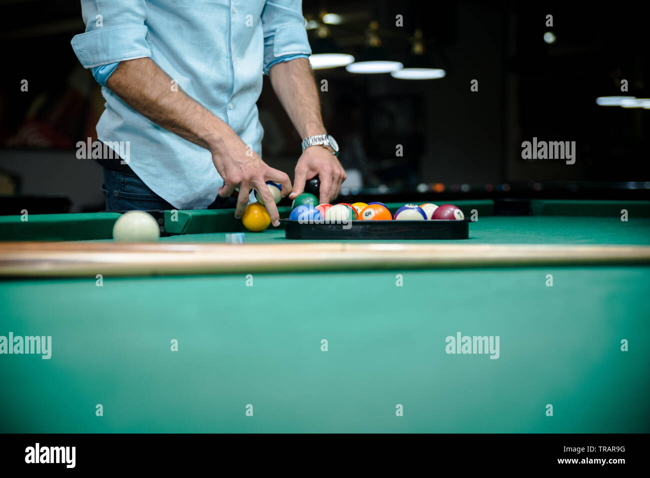 Young handsome man with beard plays billiards Stock Photo - Alamy