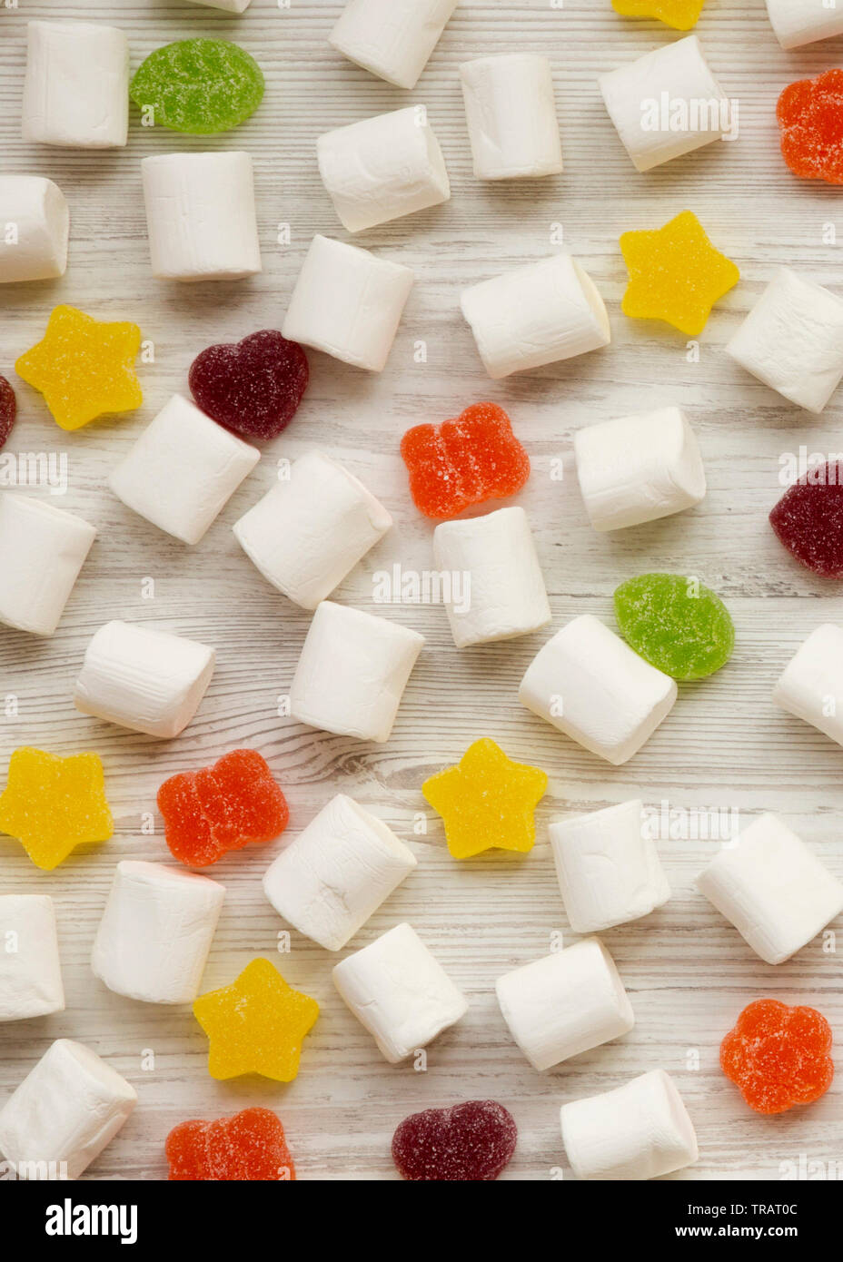 Candy on a white wooden background, top view. From above, flat lay ...