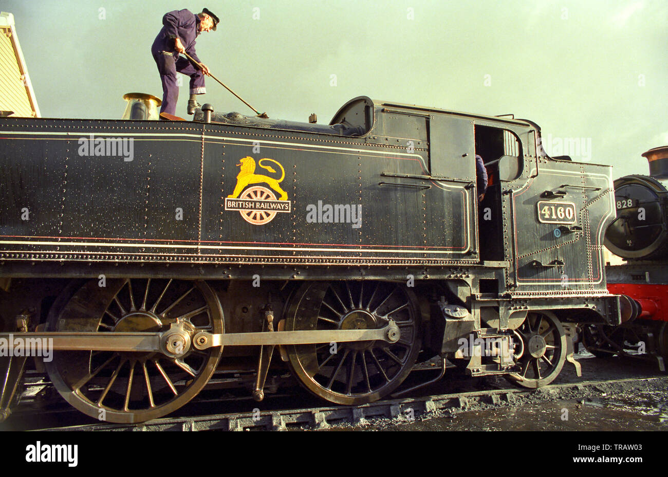 West Somerset Steam Railway, Minehead, Somerset, England. Volunteers clean and polish the steam ...