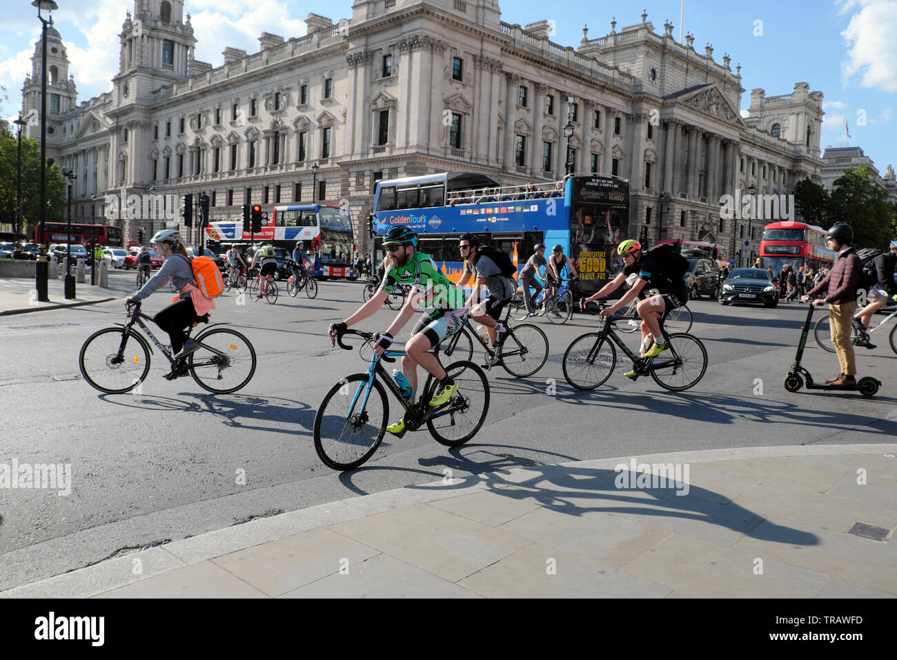 Cyclists office workers heading home after work riding bikes by Houses ...