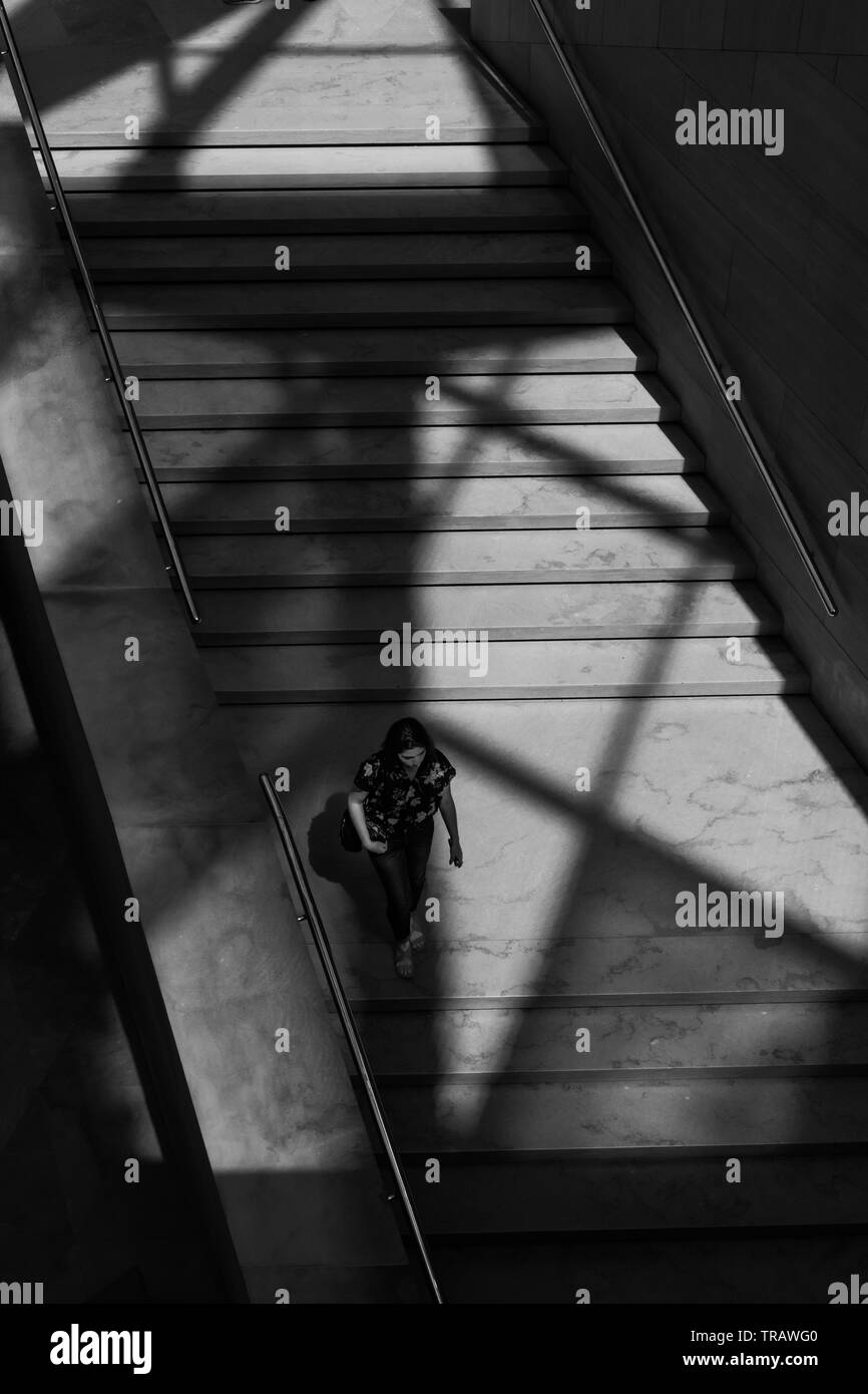 Woman descending stairs hi-res stock photography and images - Alamy