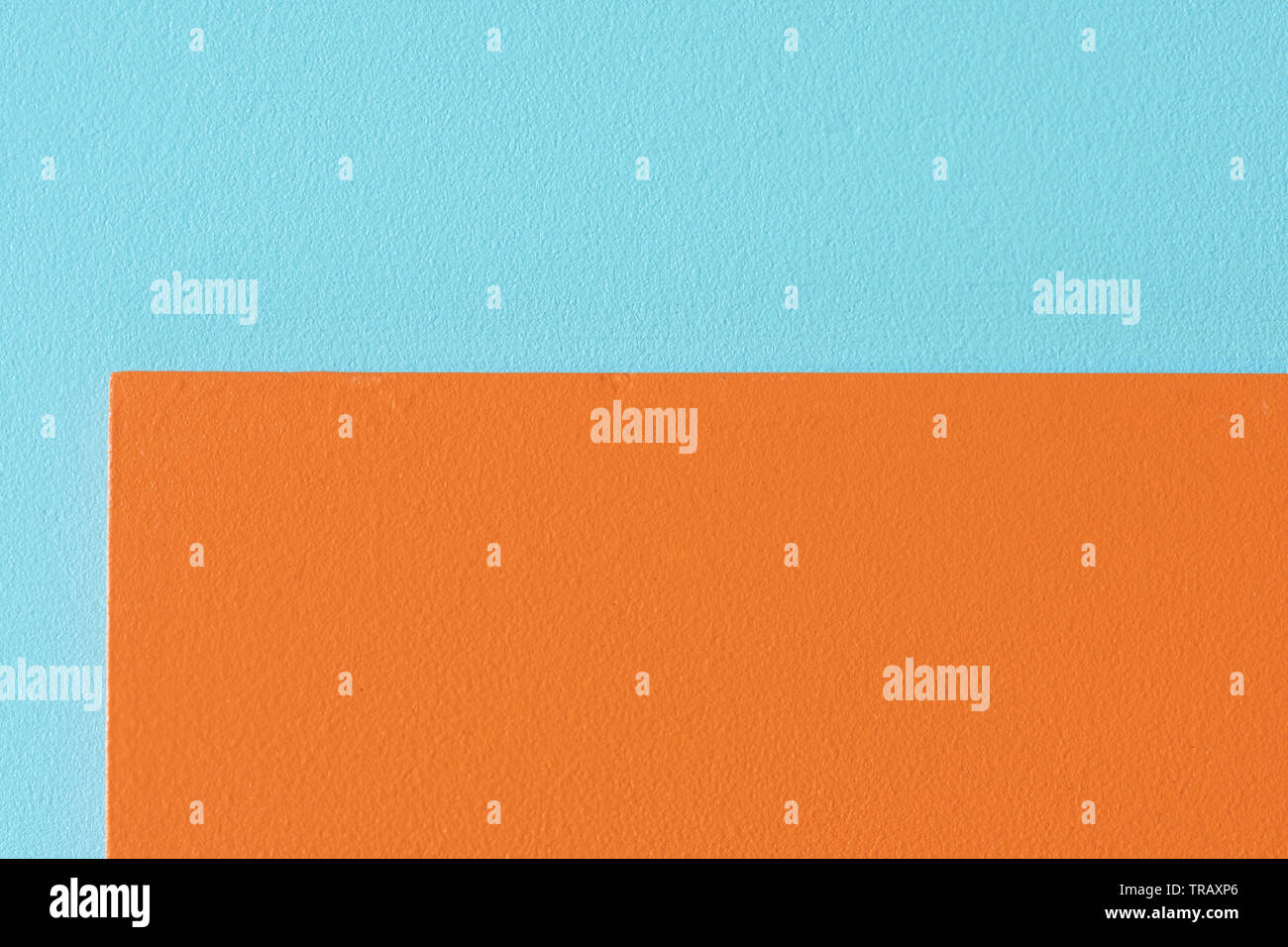 Close up abstract image of orange and light blue painted wooden panels ...