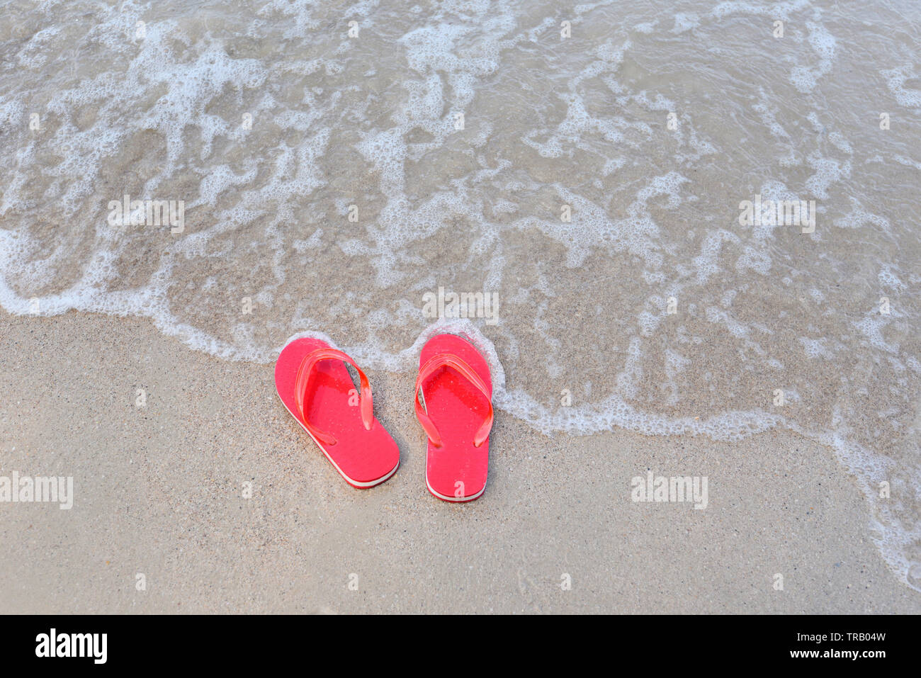 flip flops on beach with wave sandy beach sea at the ocean - top view ...