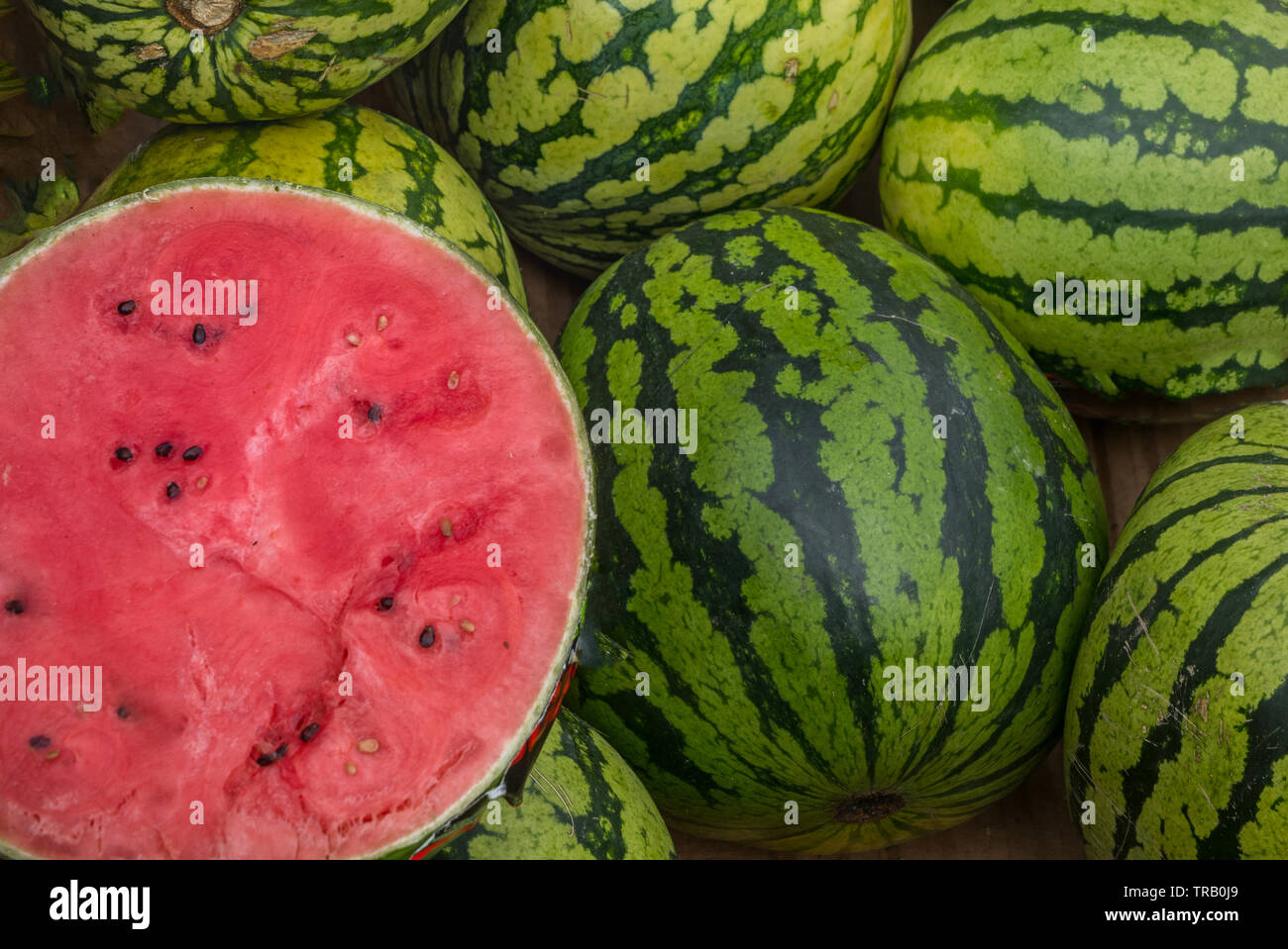 Many big sweet green watermelons and one cut watermelon.Young green ...