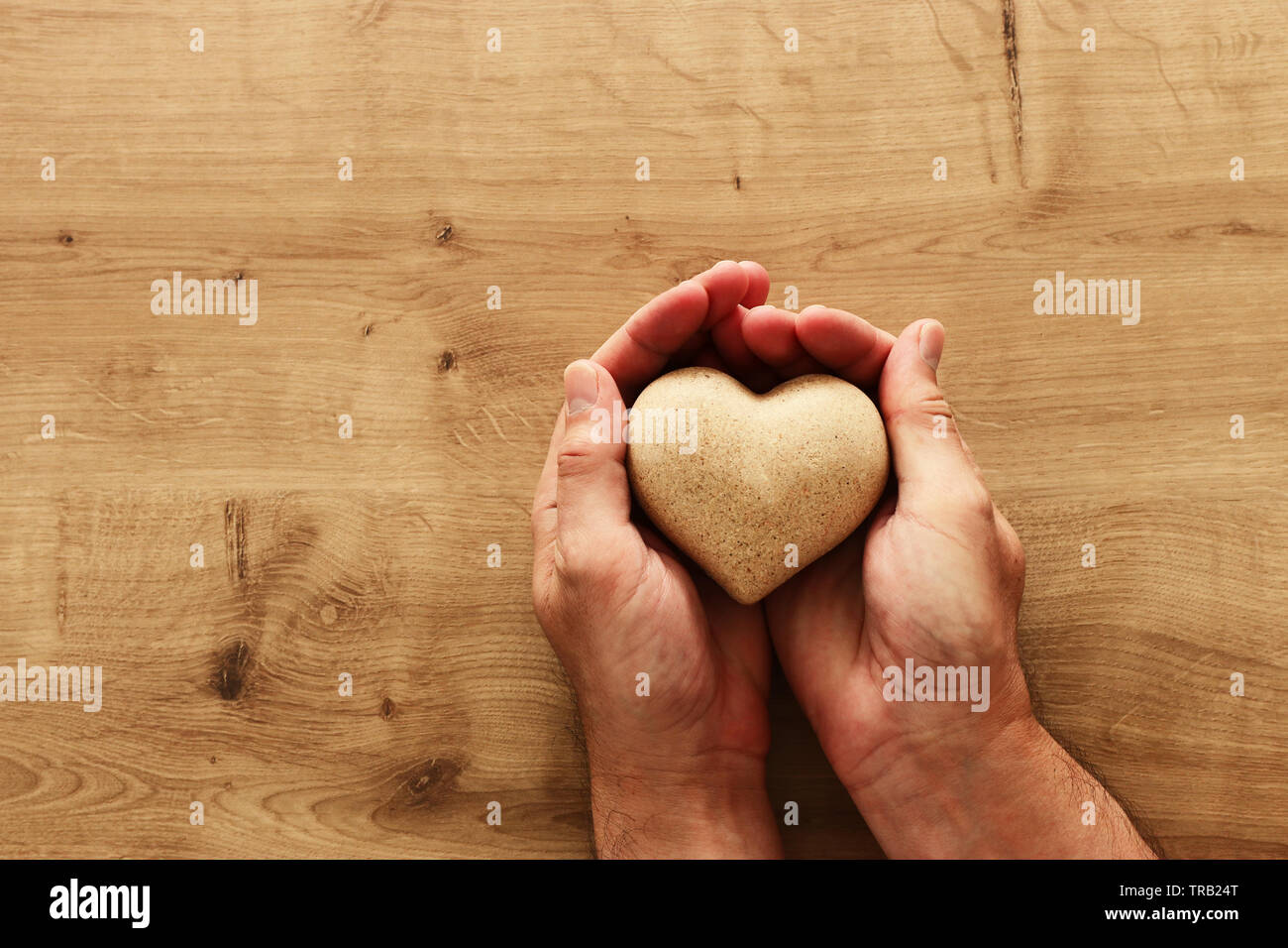 People hold hands over heart hi-res stock photography and images - Alamy