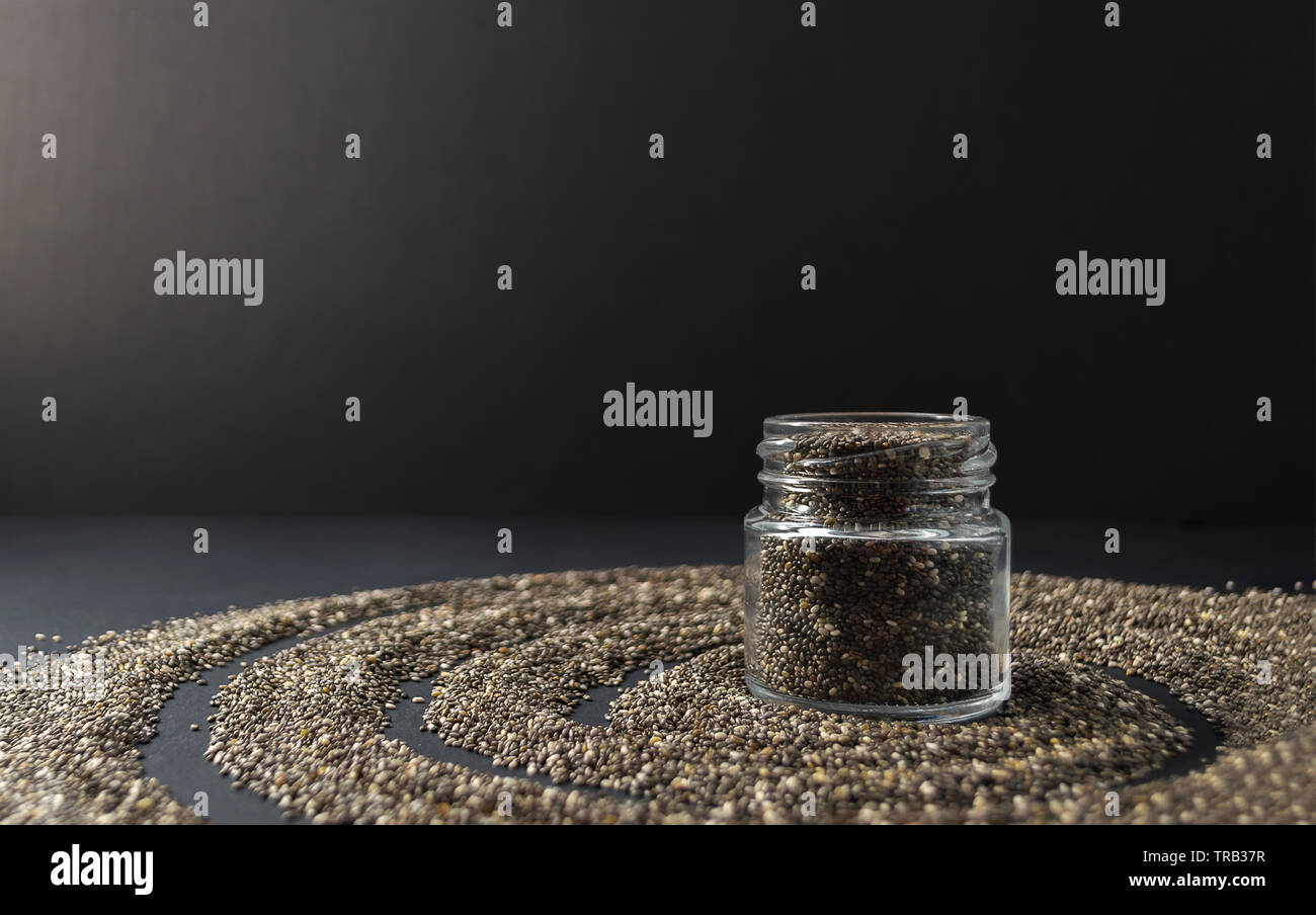 Small jar with chia seeds on black background. Copy space. Chia ...