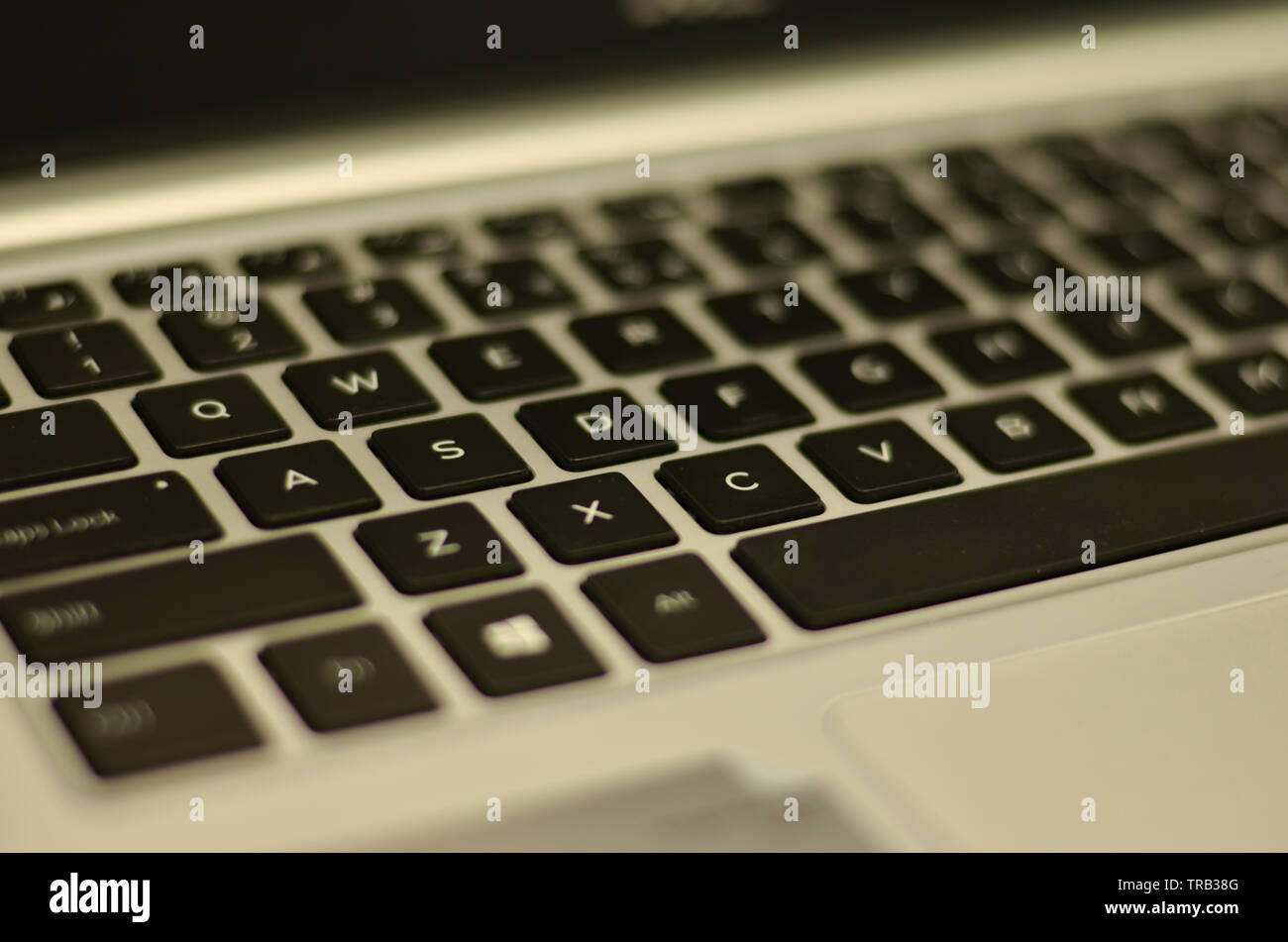 Abstract view of qwerty keyboard in an office setup Stock Photo - Alamy