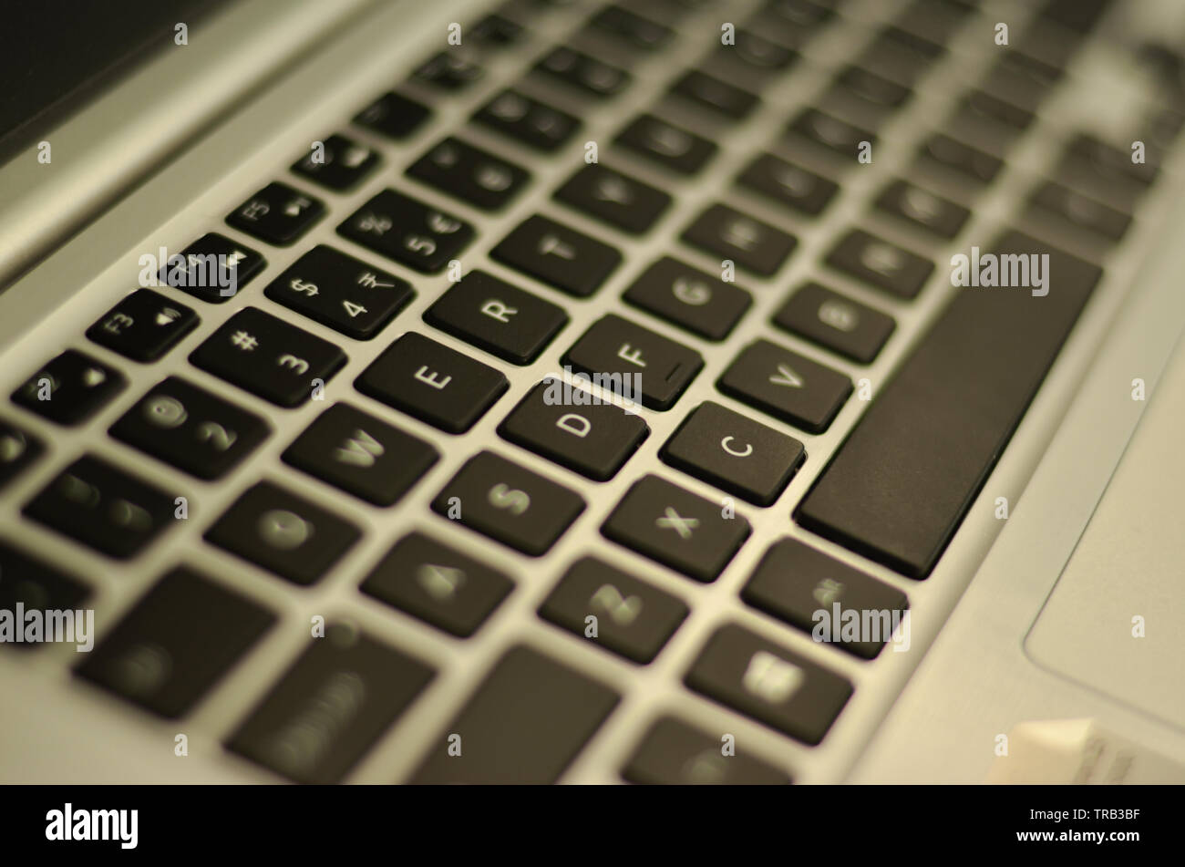 Abstract view of qwerty keyboard in an office setup Stock Photo - Alamy