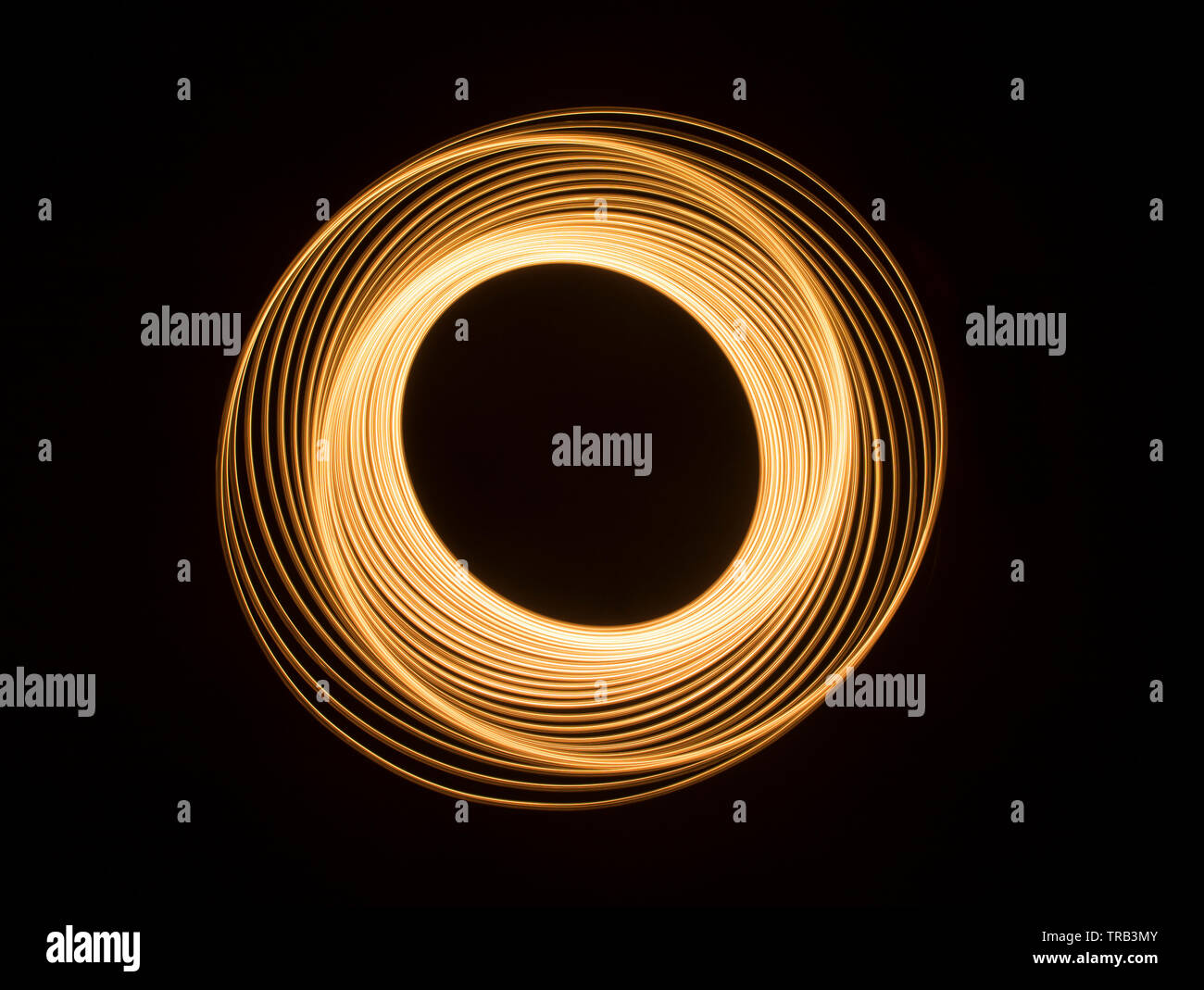 Circular light trails against black background Stock Photo - Alamy