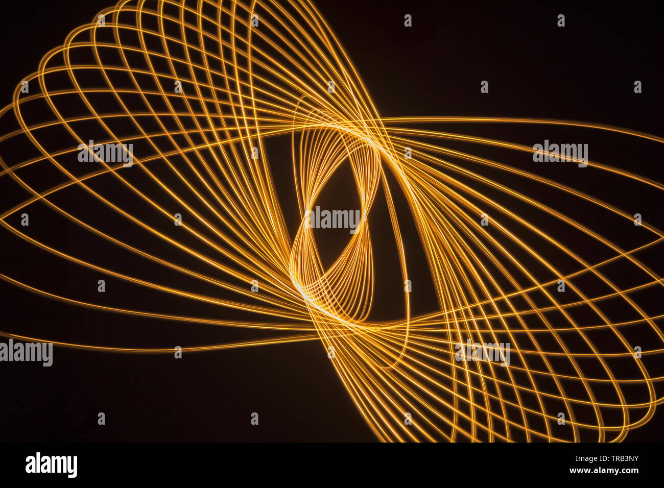 Light trail patterns against black background Stock Photo - Alamy