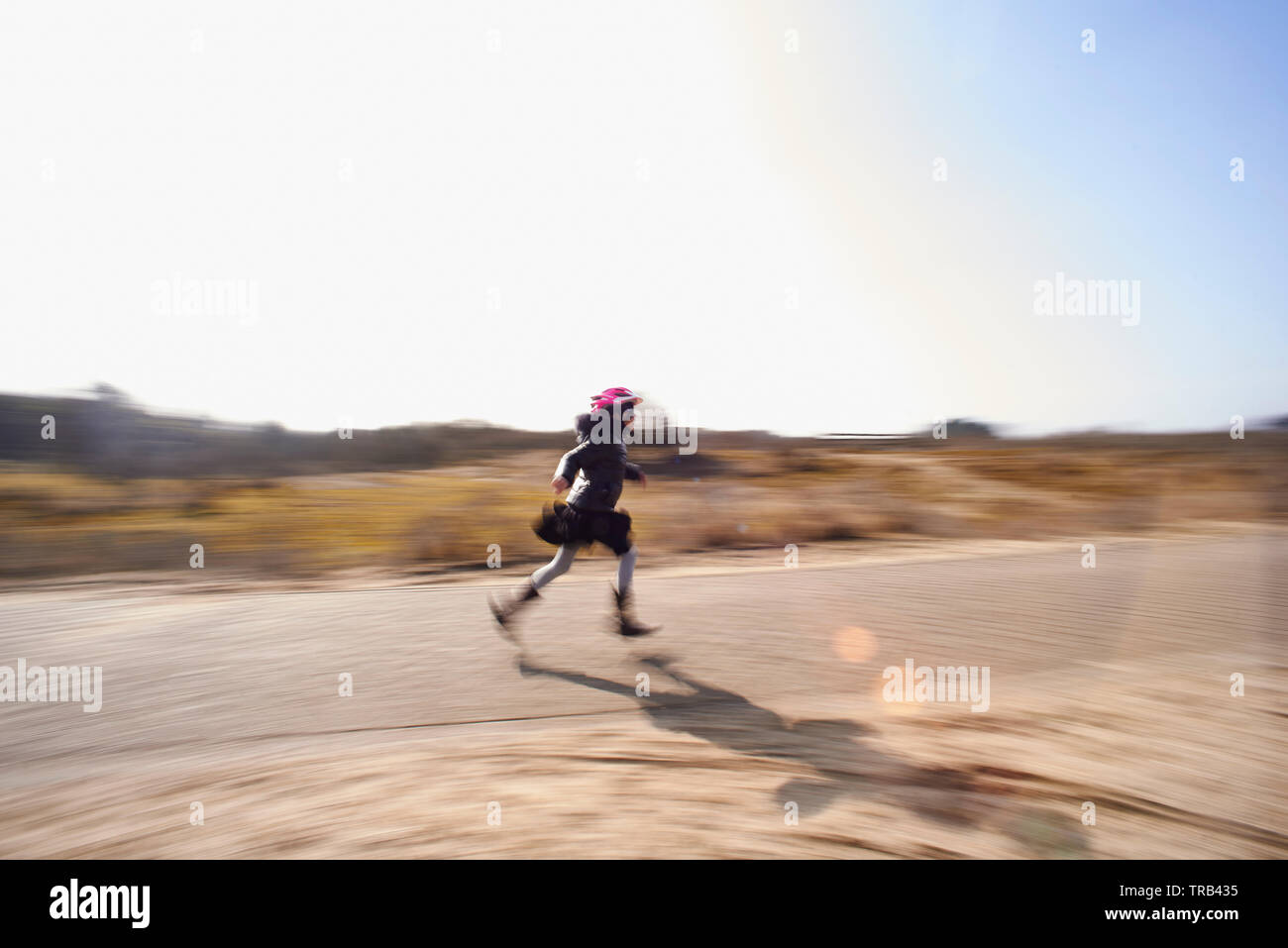 Two young girls running down a path in summer sunshine having fun Stock ...
