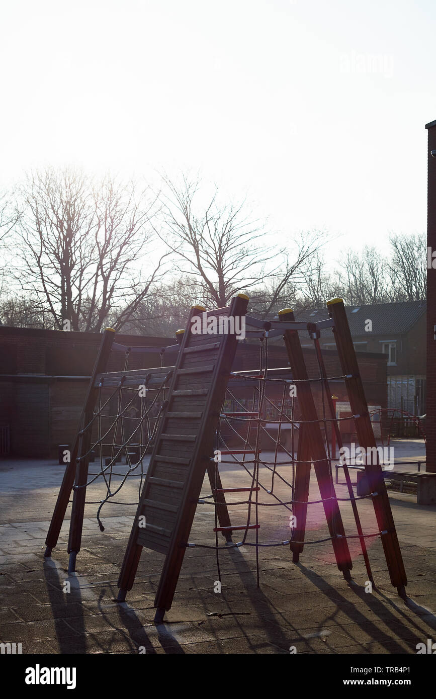 Close up of the legs of young children climbing up on a rack at a ...