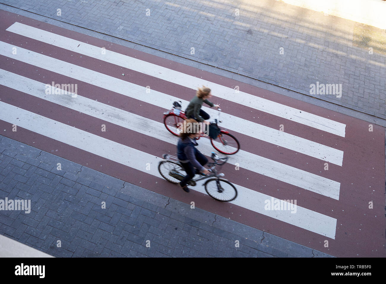 Amazing dynamic shot of people riding their bikes in the city centre of ...