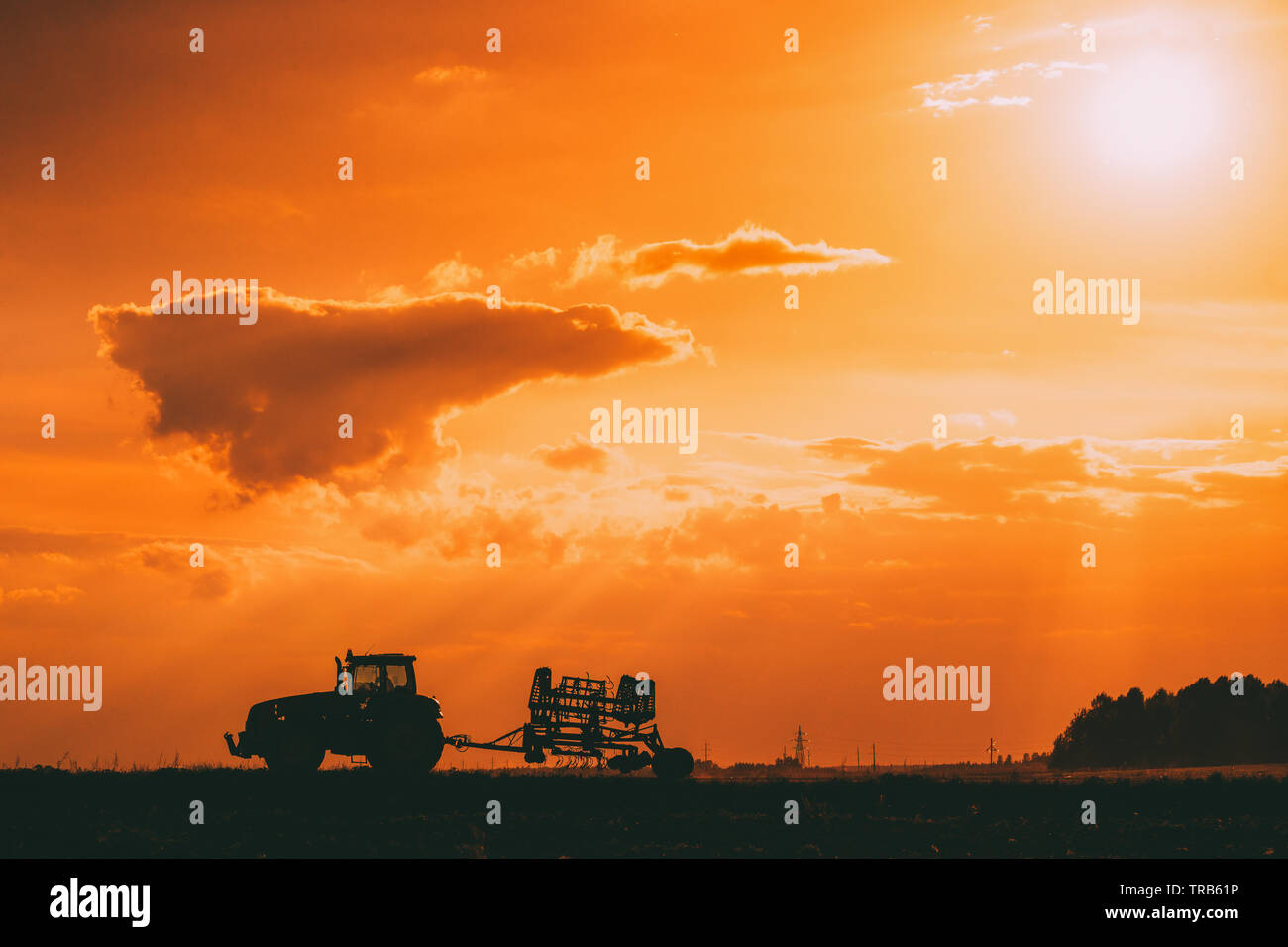 Tractor Rides On Countryside Road. Beginning Of Agricultural Spring ...