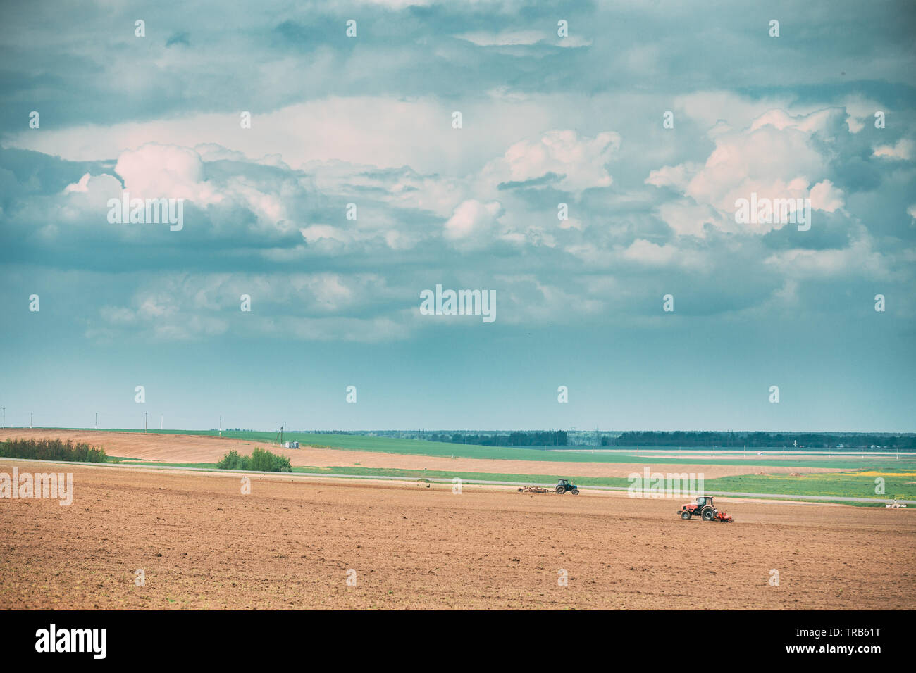 Two Tractors Plowing Field In Spring Season. Beginning Of Agricultural ...