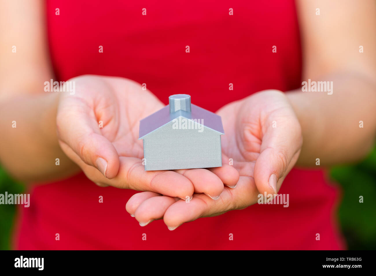 Close up picture of 3d printed house in female hands , new investments ...