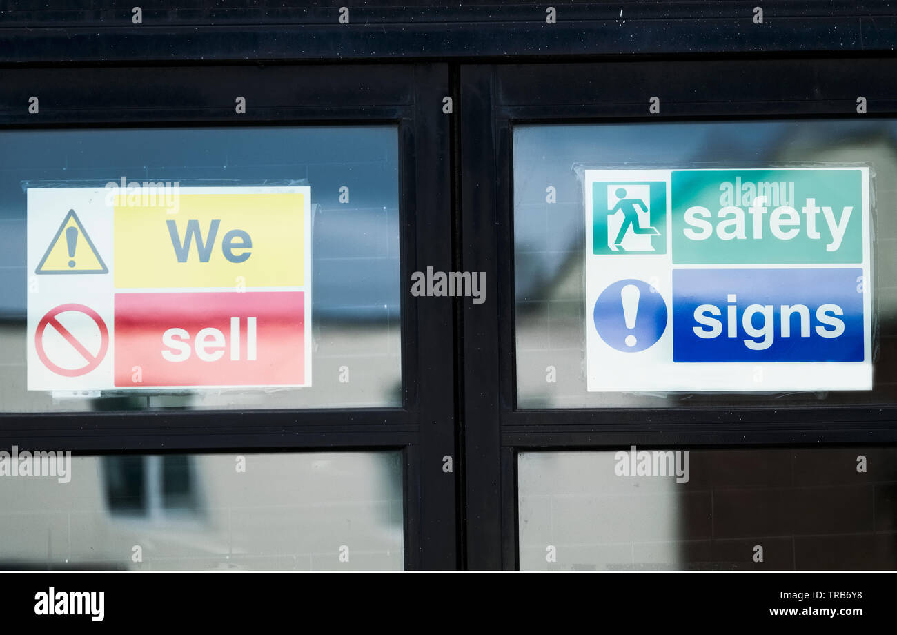 Shop selling safety signs signage on door window Stock Photo - Alamy