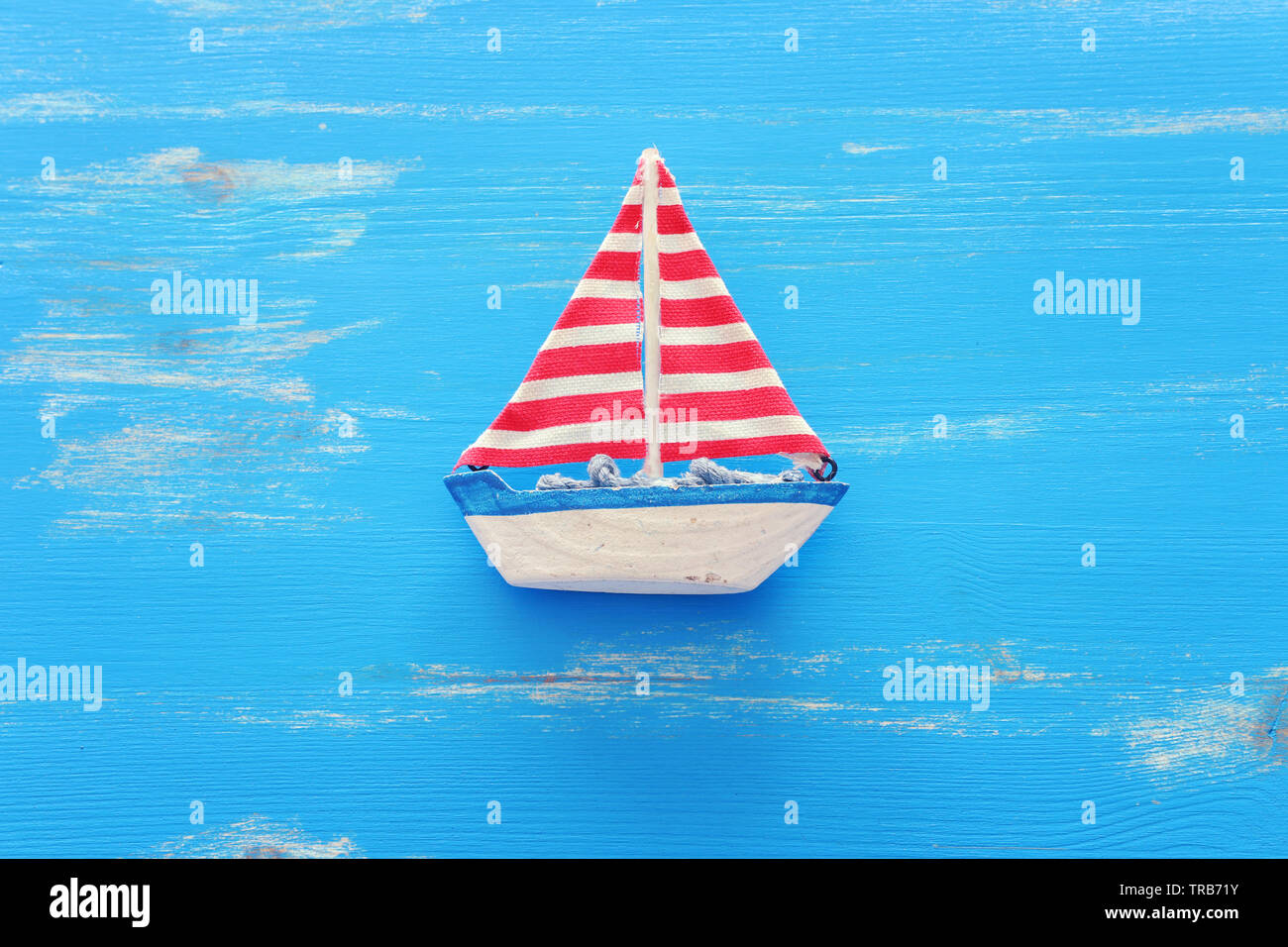 wooden vintage boat over blue background Stock Photo - Alamy