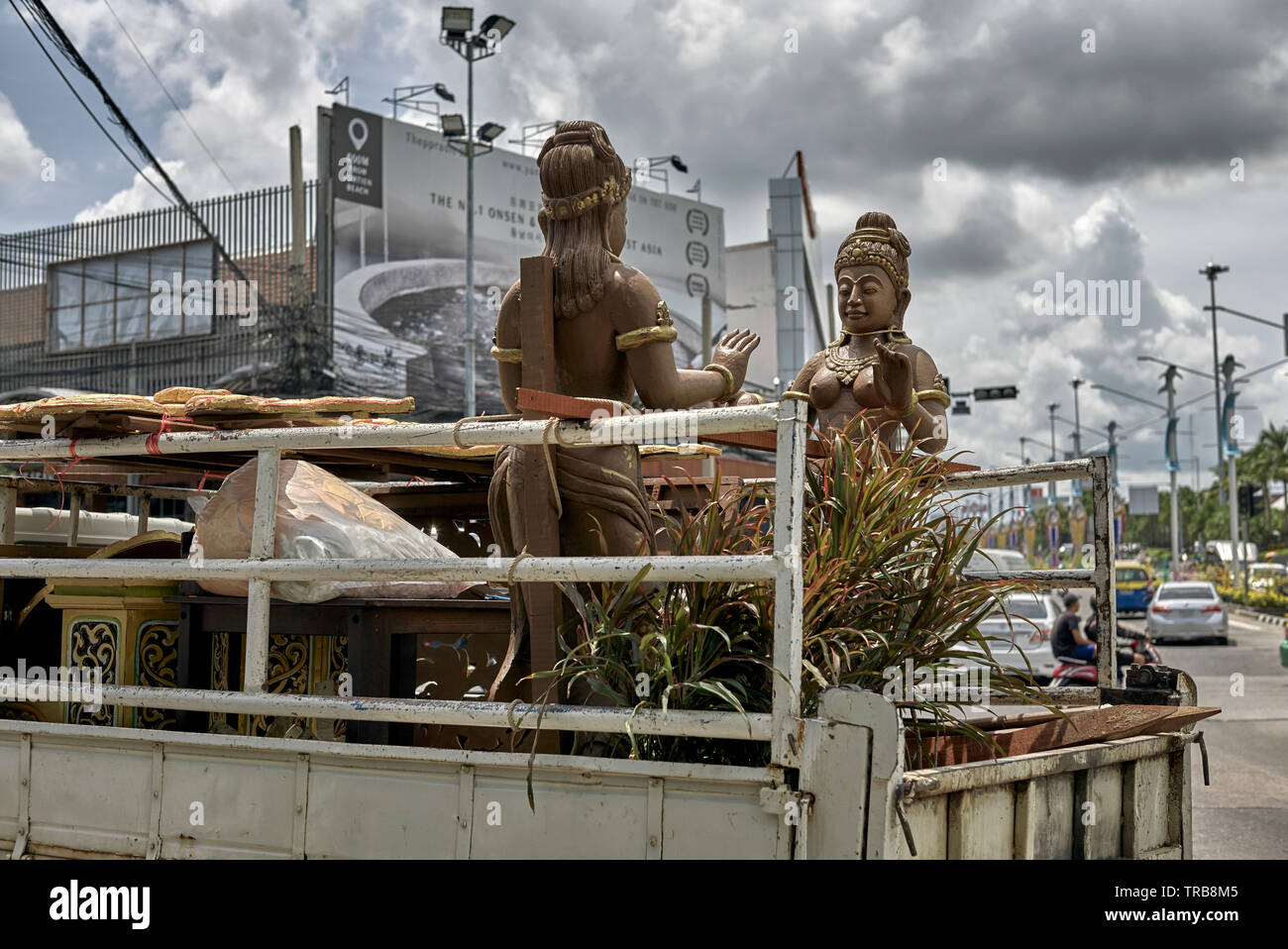 Transporting Buddha and female deity statues on the back of a lorry ...