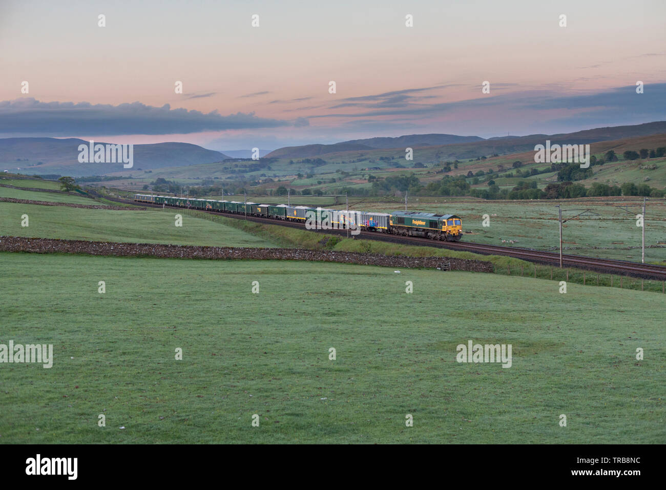 A Freightliner Class 66 locomotive climbing Shap bank, on the west ...