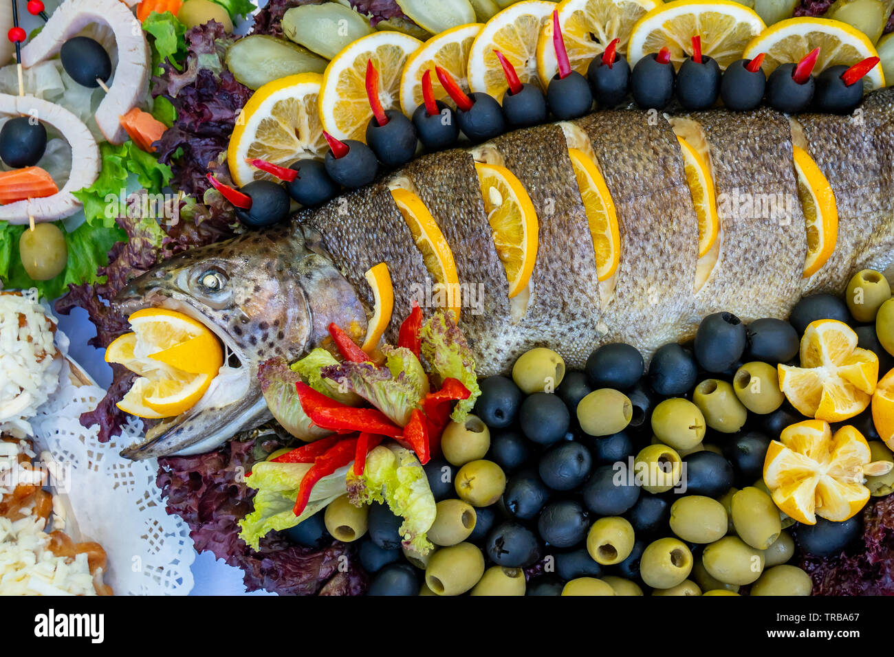 Grilled trout, carp and mullet. Juicy delicacy fish on a plate with a ...