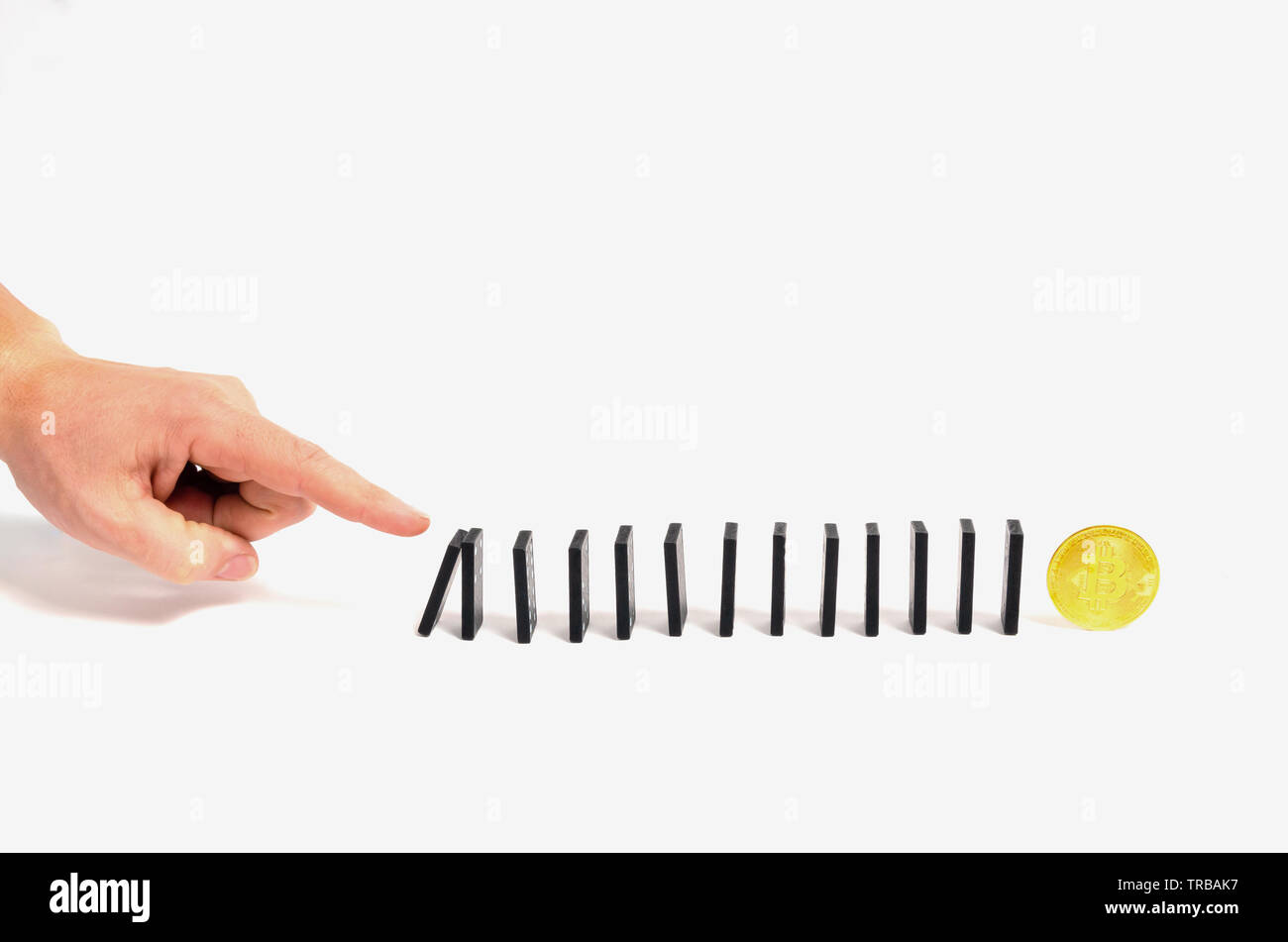 Human hand pushing dominoes on the bitcoin on a white background Stock ...