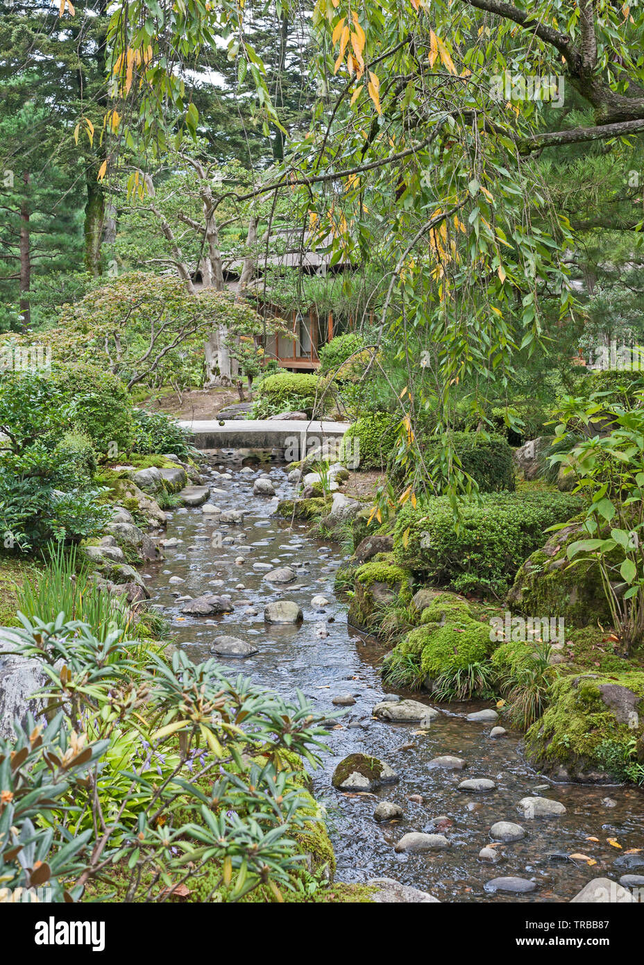 A stream with boulder walls running through the Kenroku-en Japanese ...