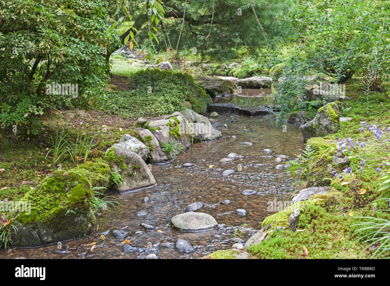 A stream with boulder walls running through the Kenroku-en Japanese ...