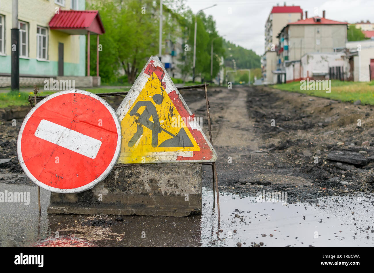 road sign, detour, road repair on the background of the road and broken ...