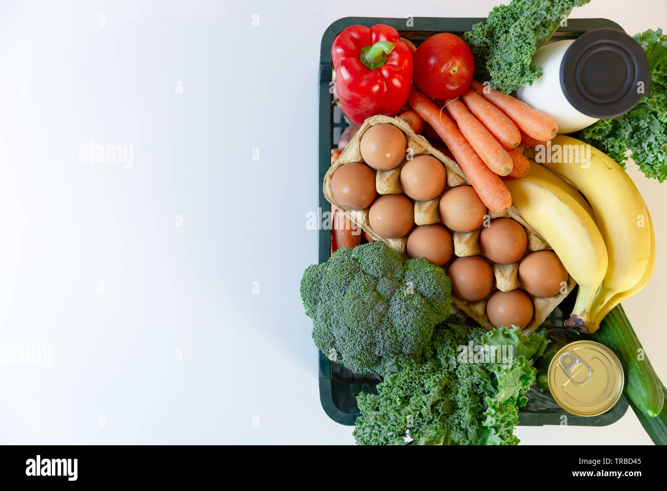 Fresh healthy groceries and vegetables from supermarket in green tray ...